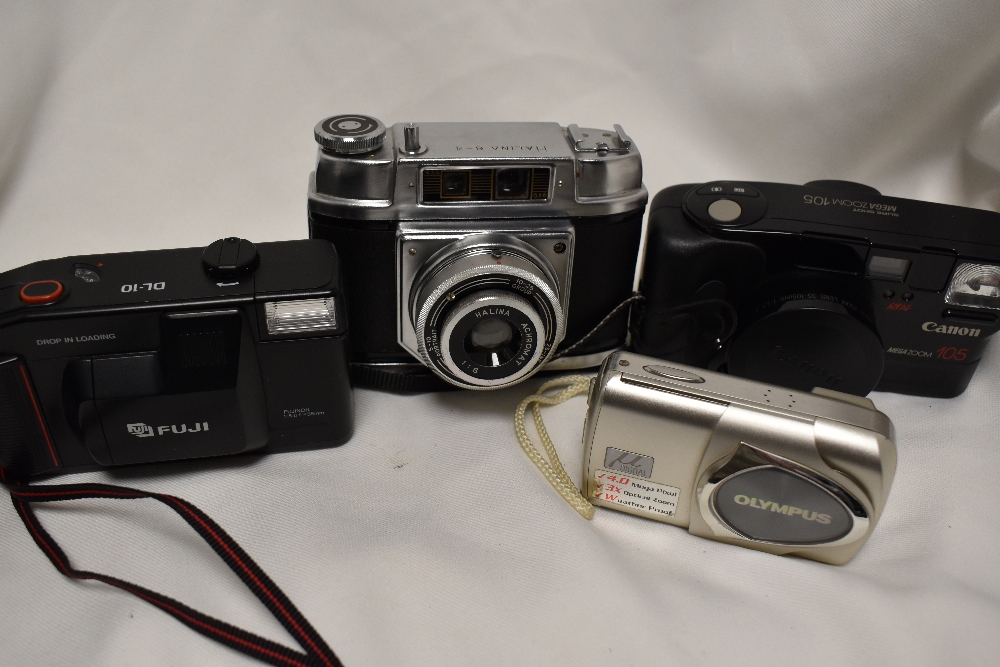 Four cameras. A Fuji DL10 Compact, and Olympus Stylus 410 Digital, a ...