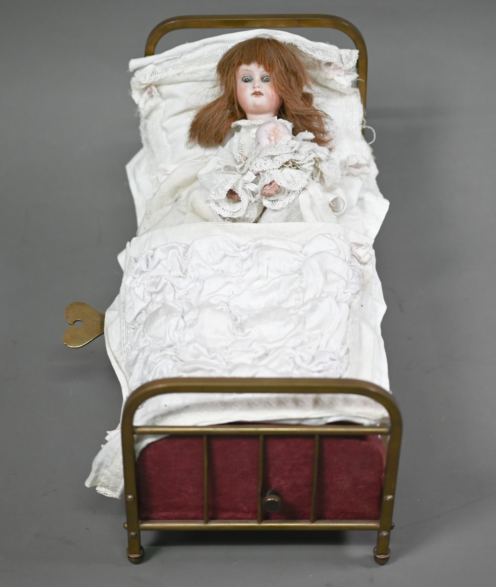 A French automaton bisque-head Armand Marseille girl doll, in a brass ...