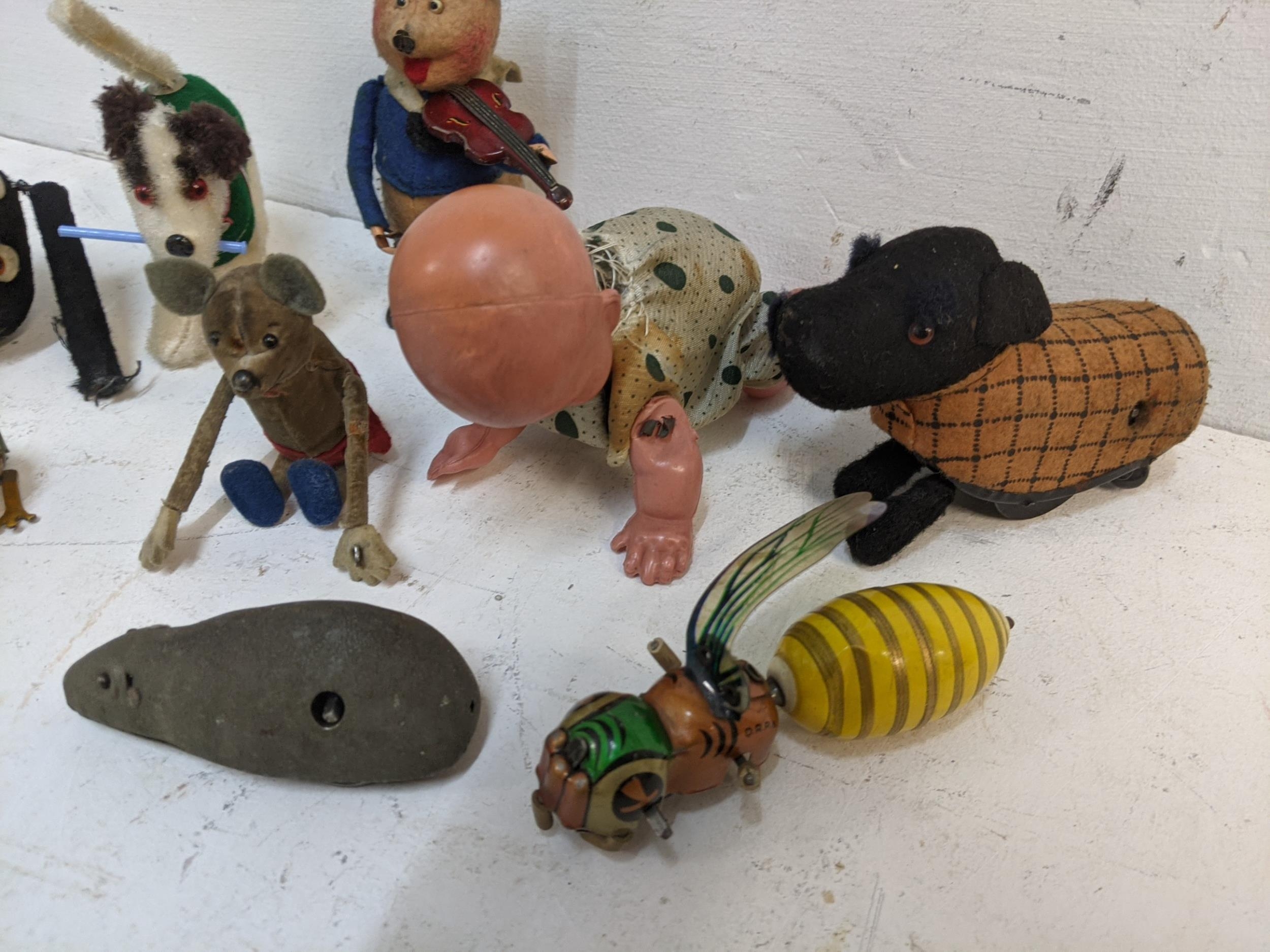 A selection of clockwork toys to include a Schuco pig playing a violin ...