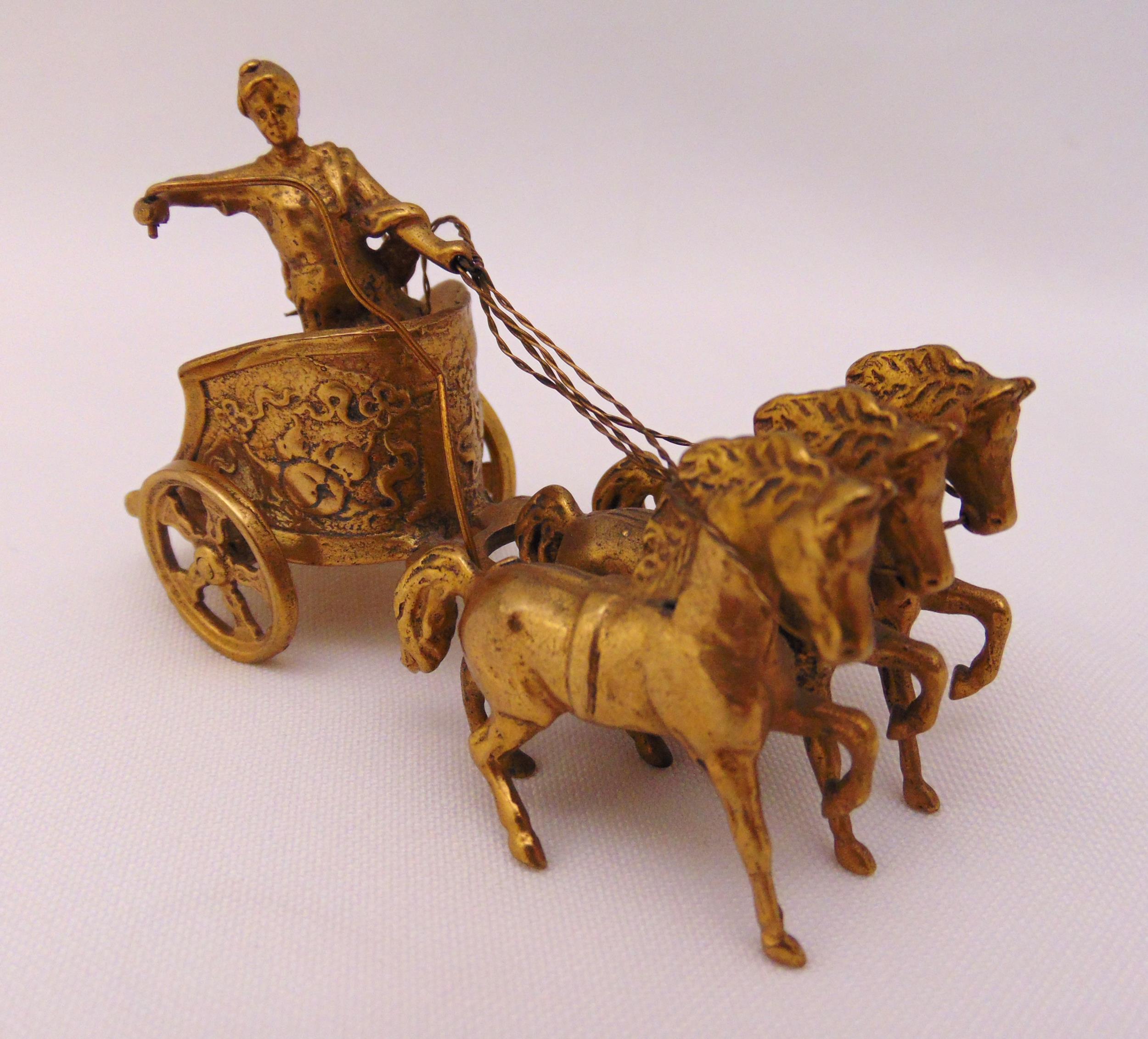 A hallmarked silver gilt model of a chariot driven by three horses ...