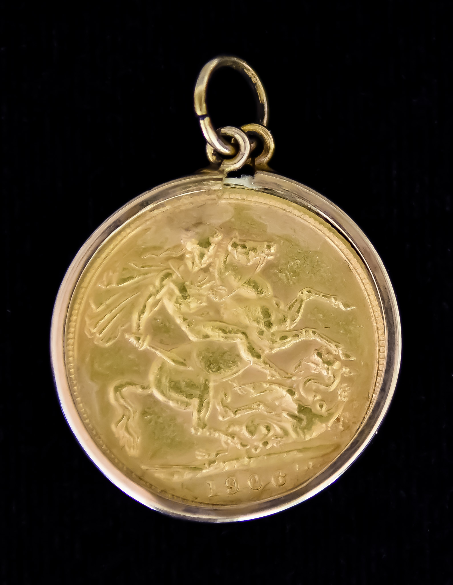 An Edward VII Sovereign, 1906, set as a pendant, in plain 9ct gold ...