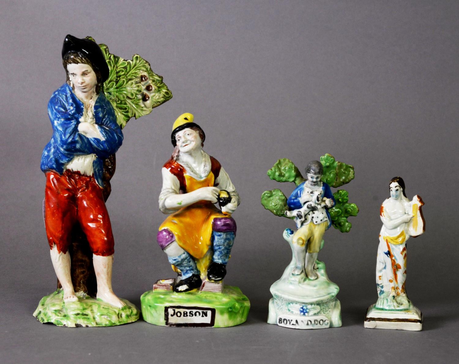 STAFFORDSHIRE SLIPWARE FIGURES INCLUDING: a ragged trousered figure ...