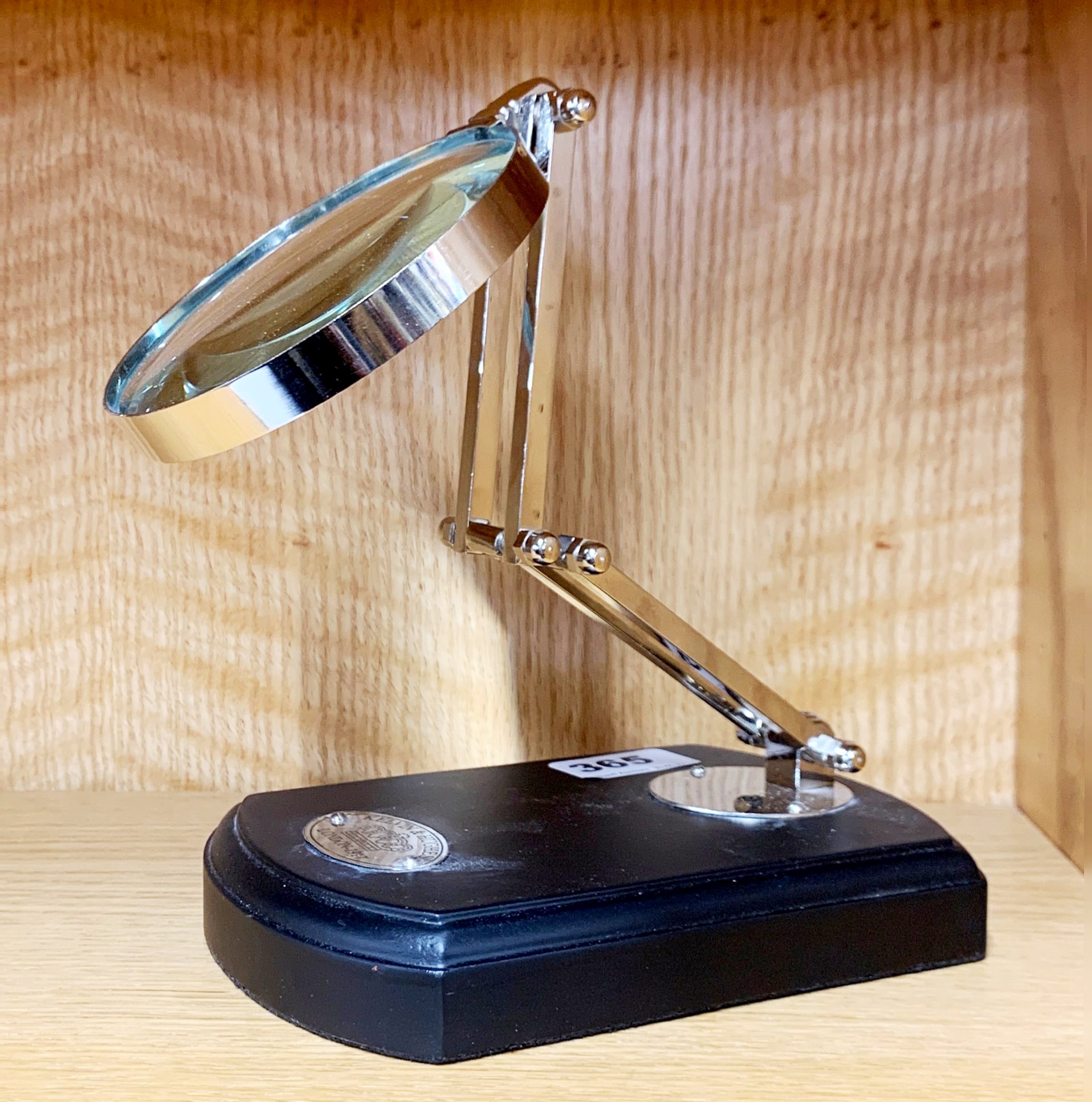 An adjustable table mounted magnifying glass.