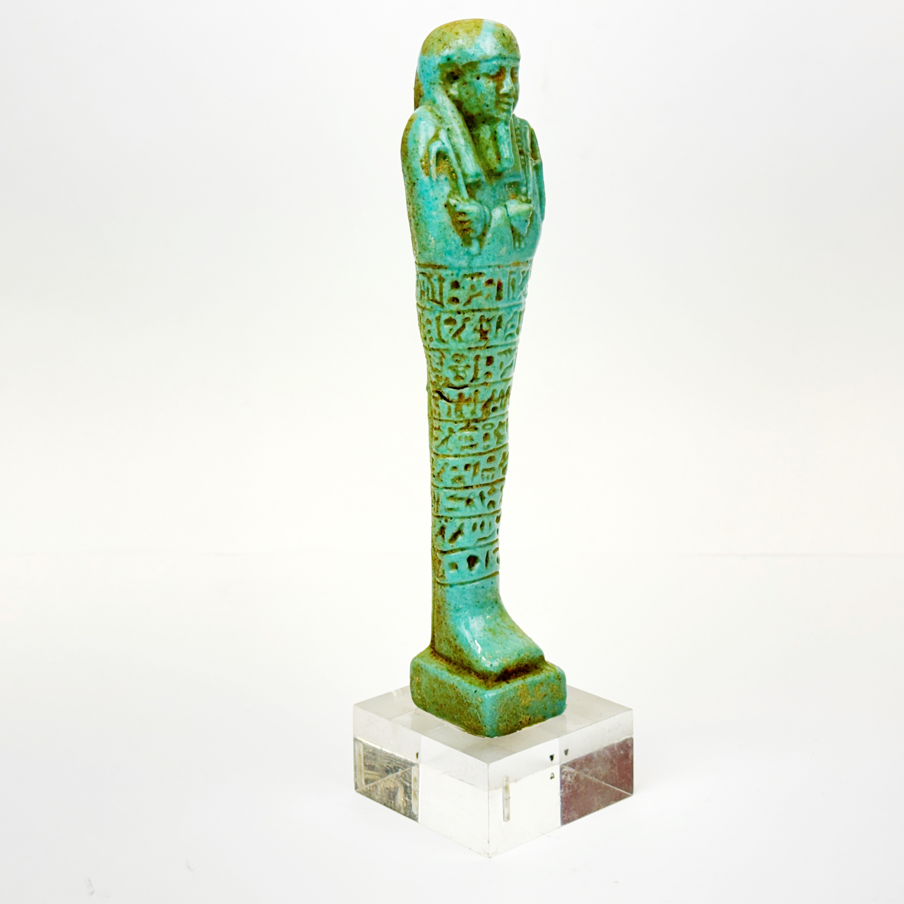 An Egyptian glazed stoneware ceramic figure of a mummy mounted on a ...