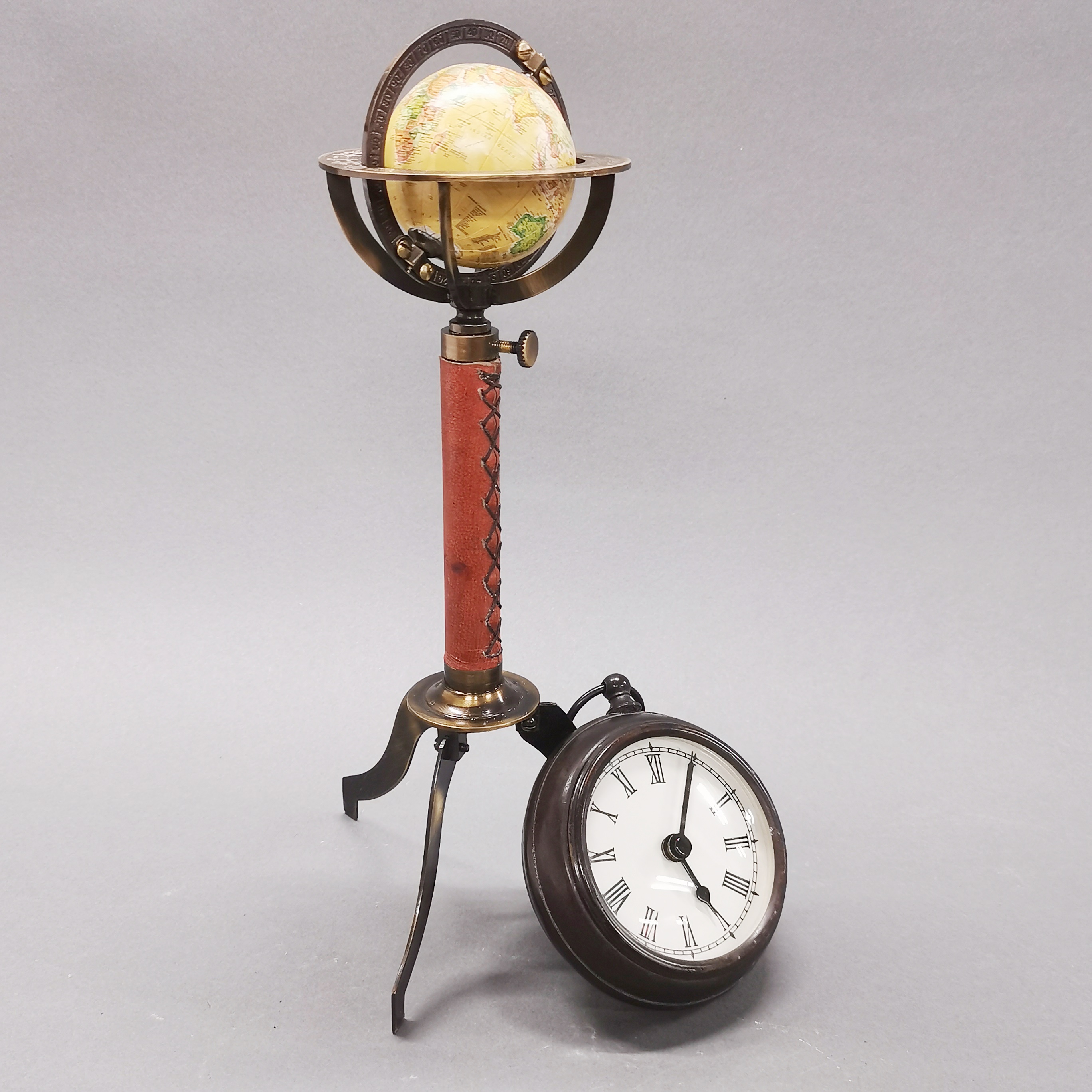 A small metal globe on stand, H. 29cm. Together with a brass ...