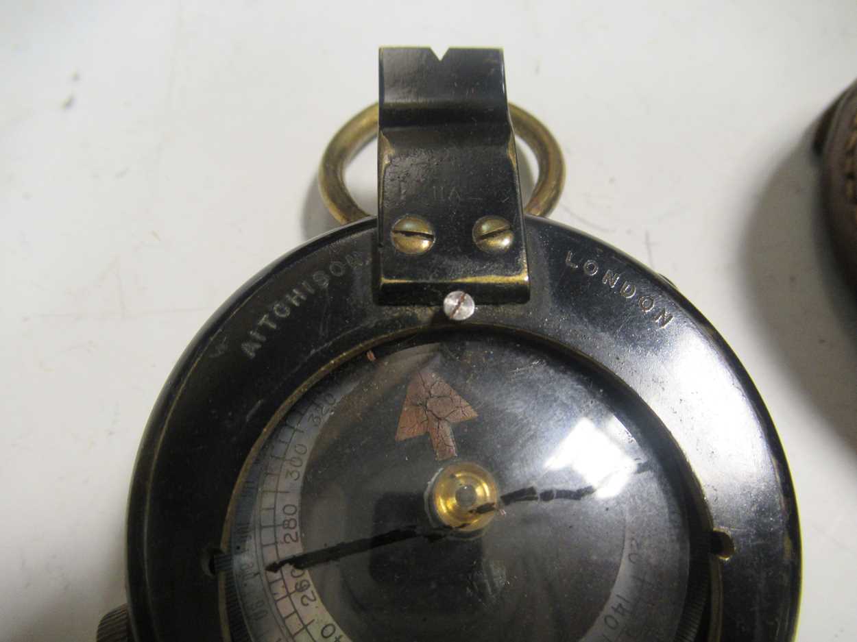 A leather cased compass, small collection brass military buttons, 2 ...