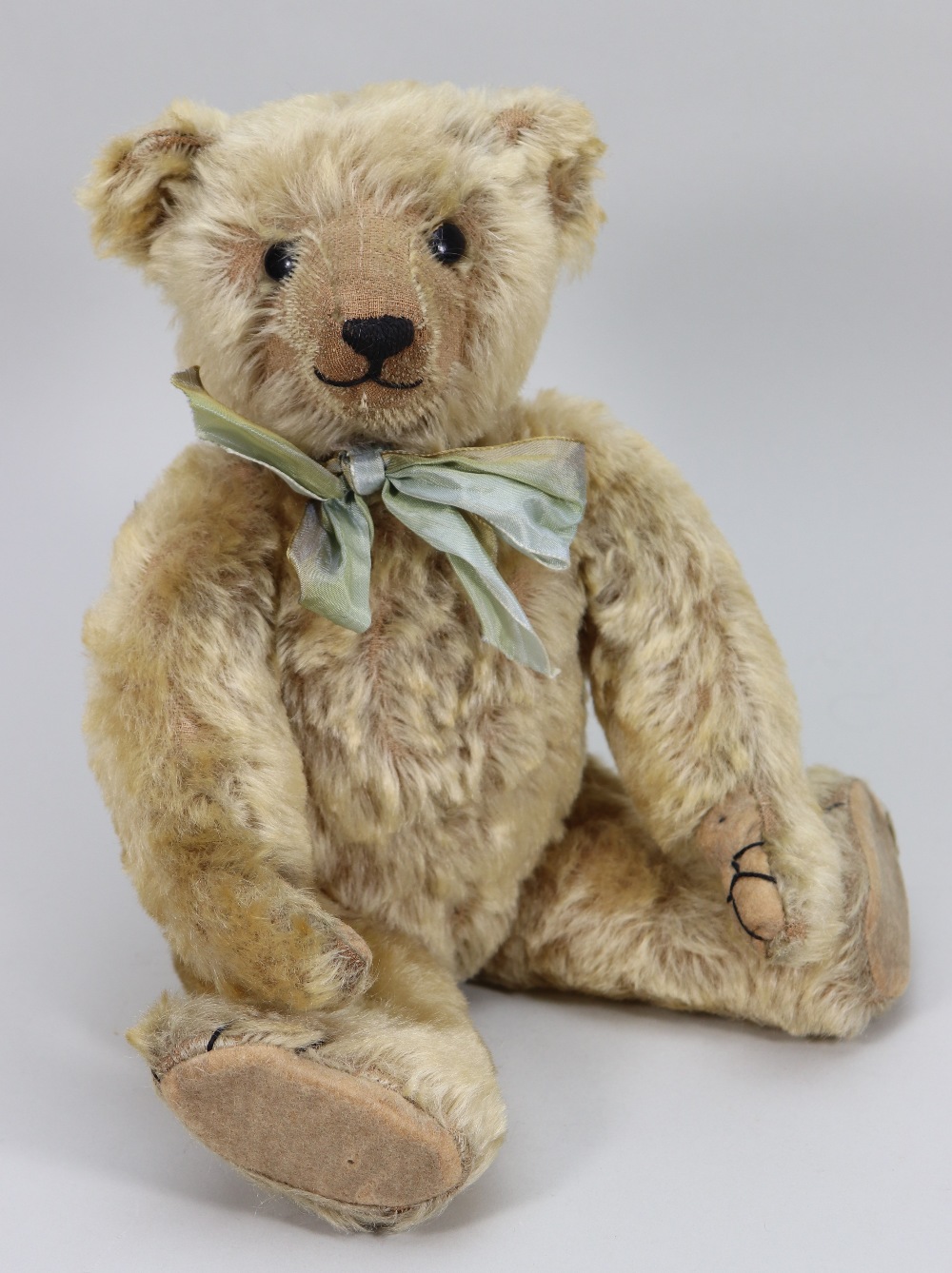 An early J.K Farnell golden mohair Teddy bear, circa 1920, the straw ...