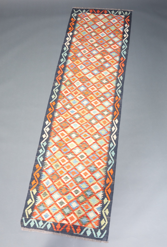 A yellow, green and orange ground Chobi Kilim runner with all over ...
