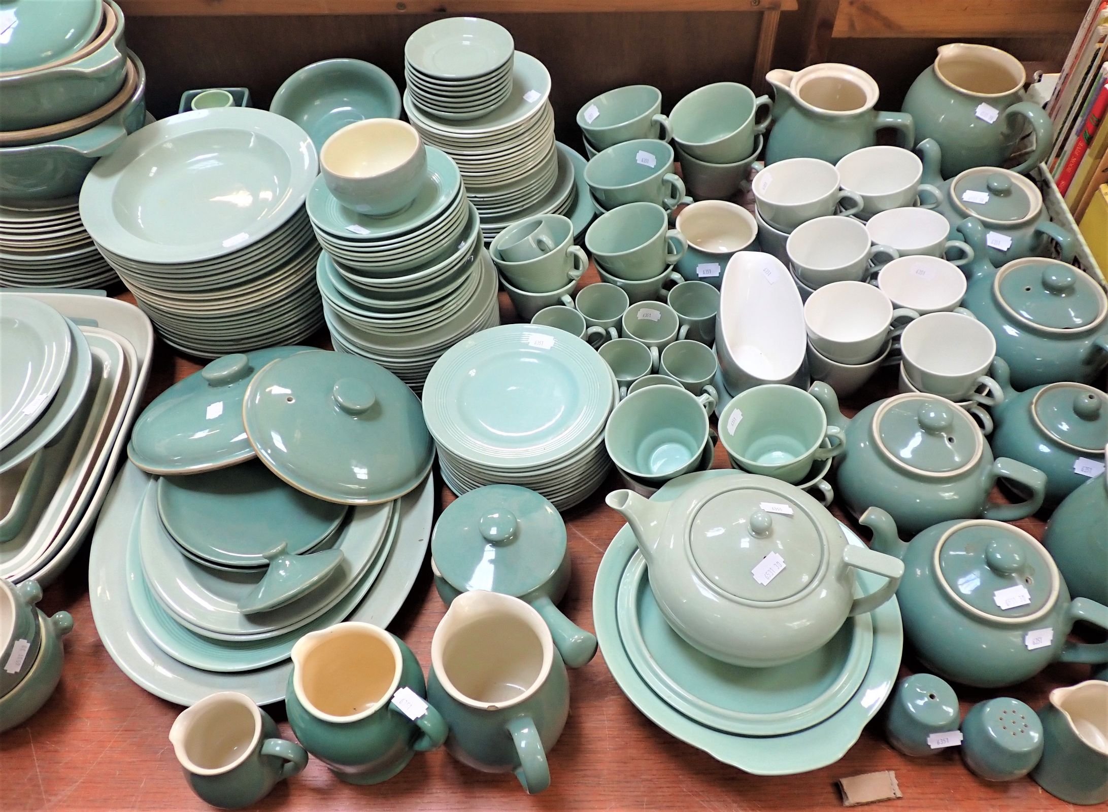 A LARGE QUANTITY OF UTILITARIAN GREEN DINNER WARE and tea ware, by ...