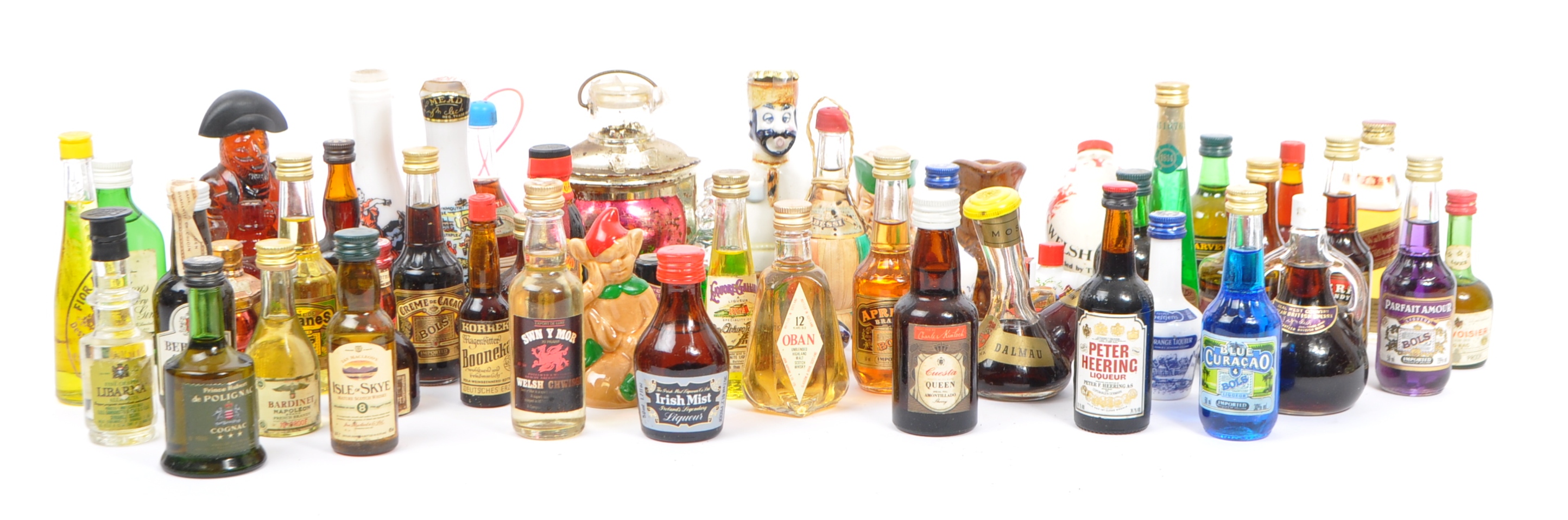 A collection of vintage 20th century souvenir alcohol bottles ...
