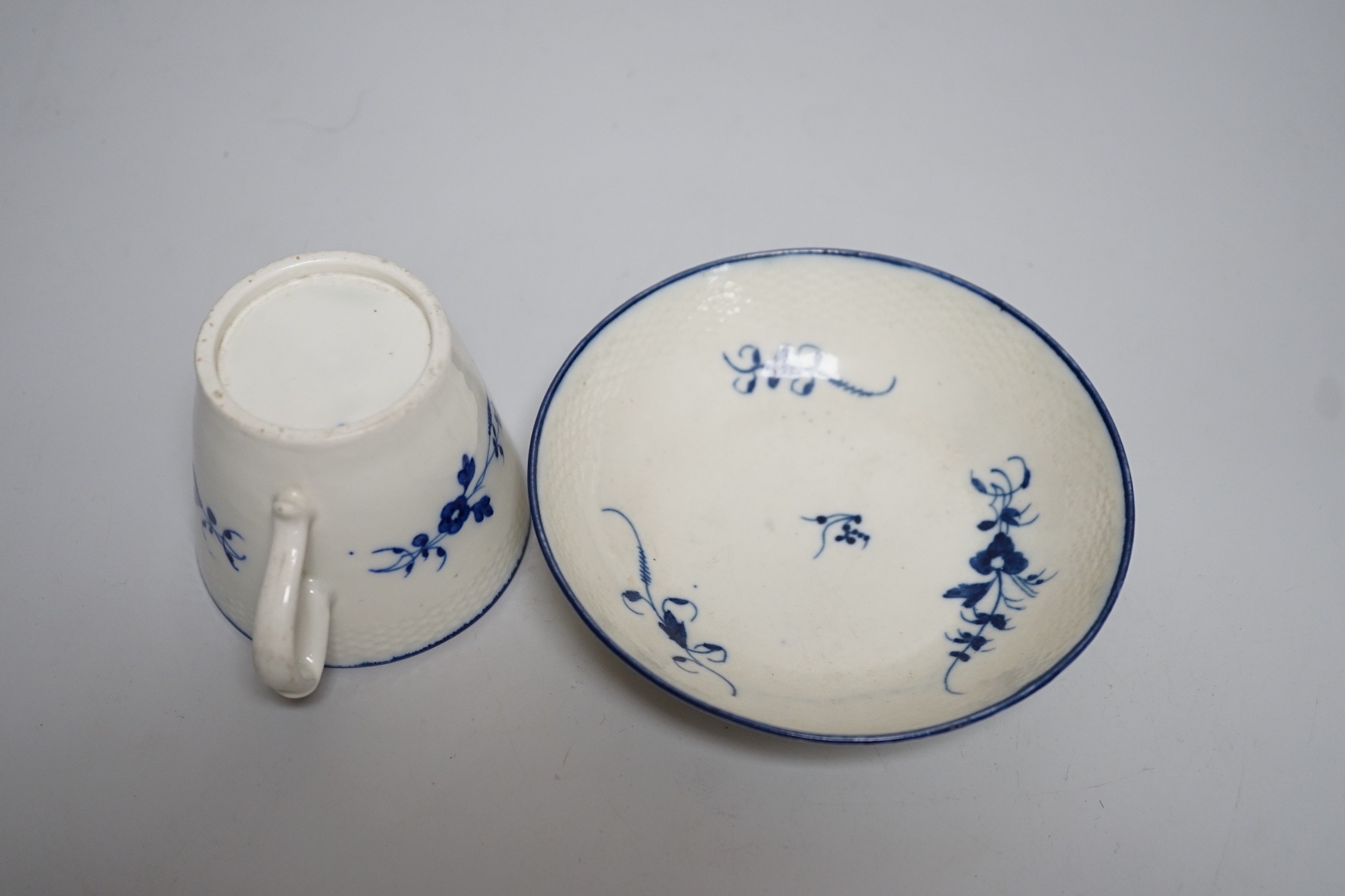An 18th century Caughley coffee cup and saucer, Chantilly sprigs under ...