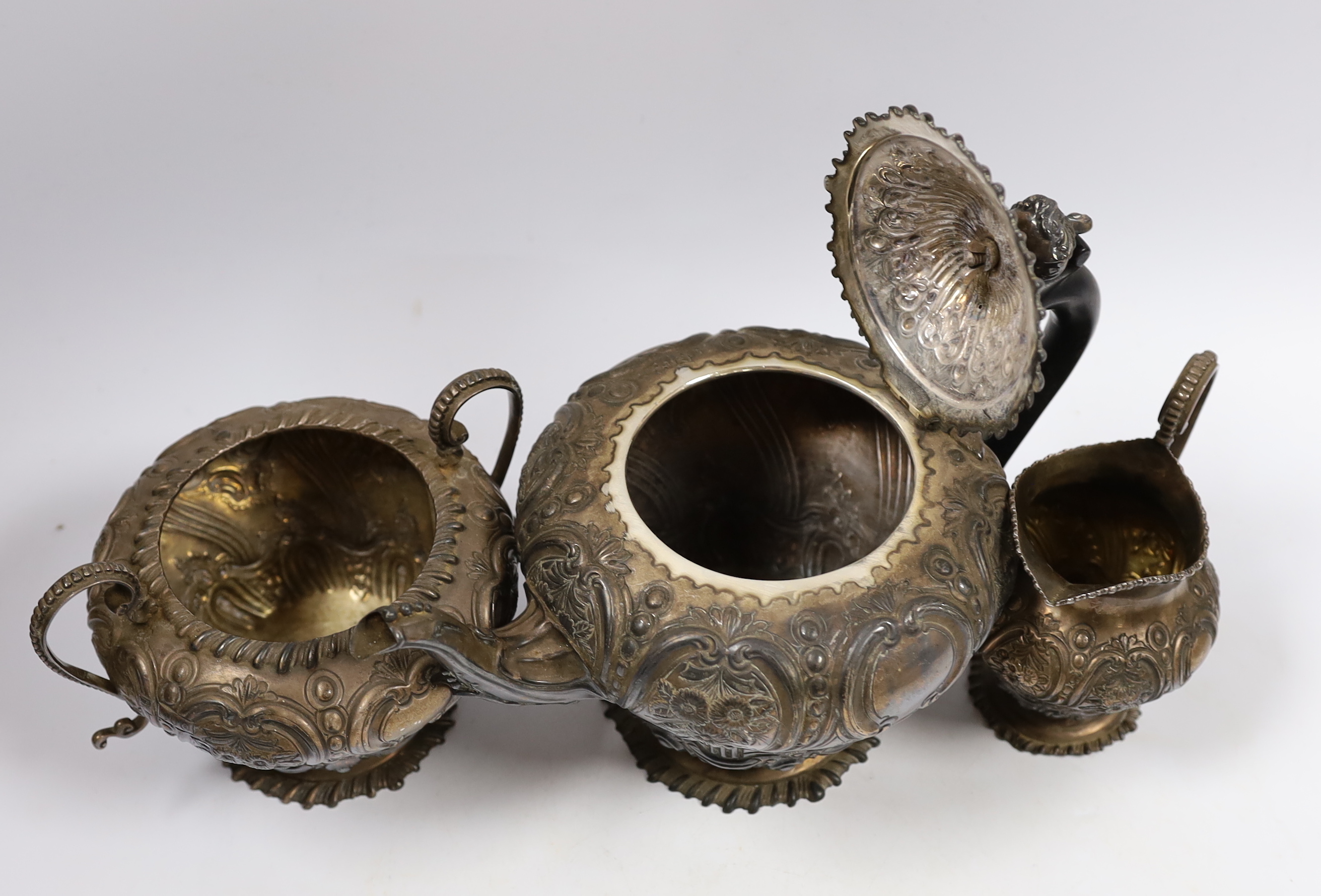 A late Victorian embossed silver inverted pear shaped three piece tea ...