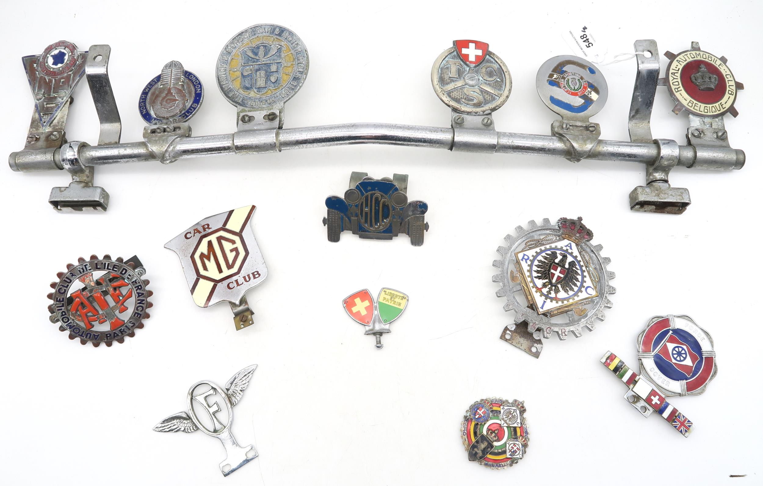 A collection of enamel automotive grille badges, to include the ...