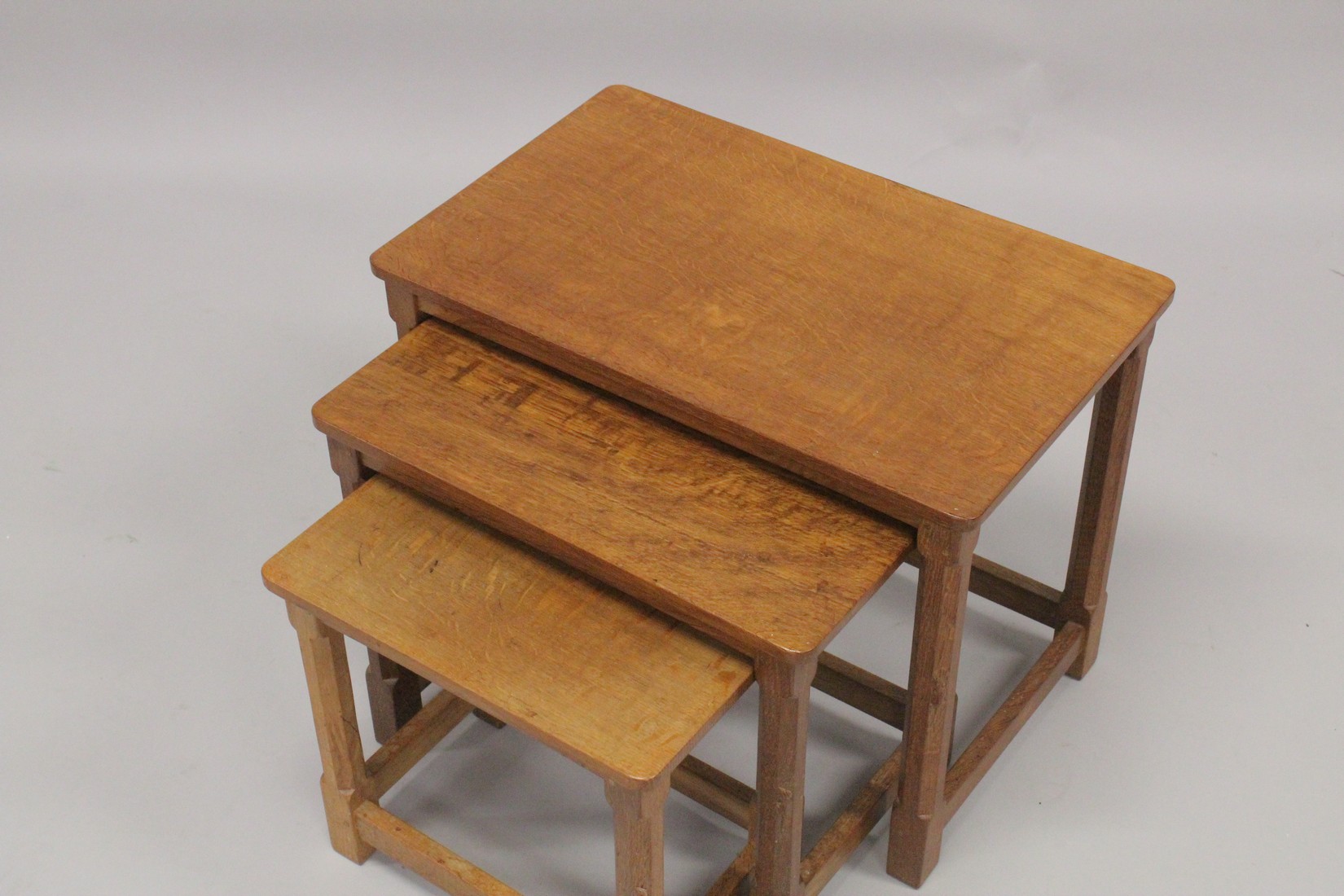 ROBERT "MOUSEMAN" THOMPSON. AN OAK NEST OF THREE TABLES, each with an ...