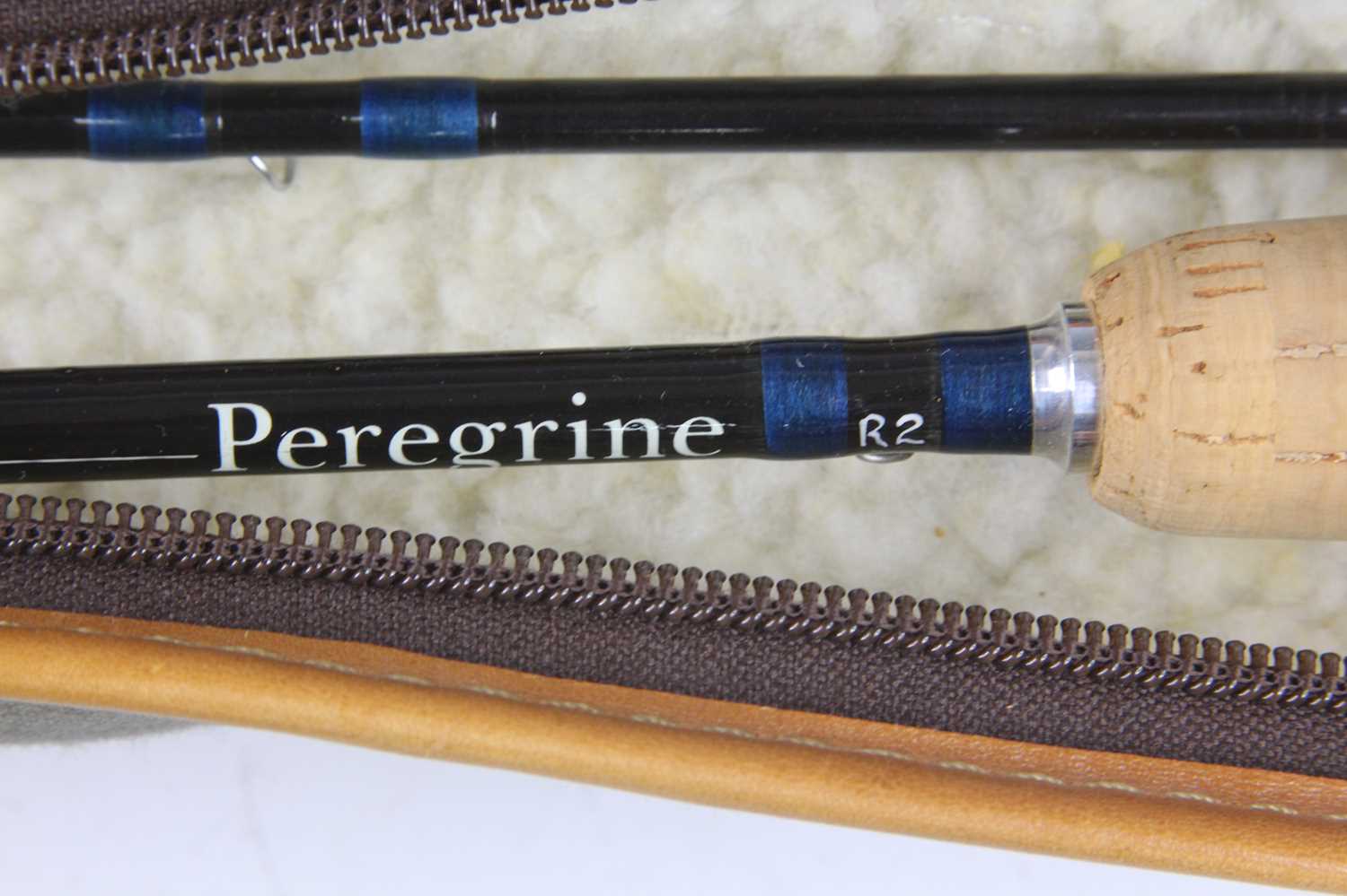 A Peregrine R2 9' two piece carbon fly rod, #5/6 No.1219, having blue ...