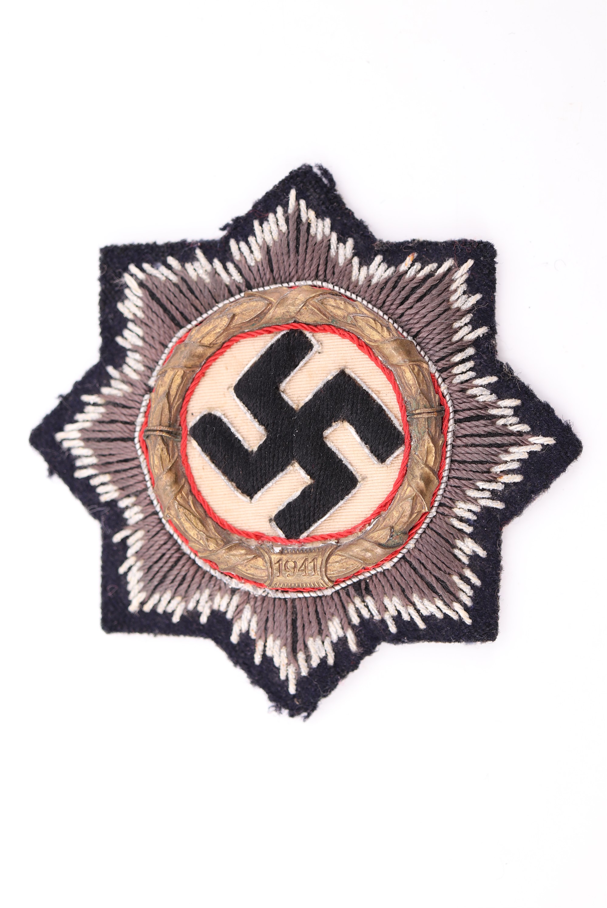 A German Third Reich German Cross in gold on Panzer black backing cloth
