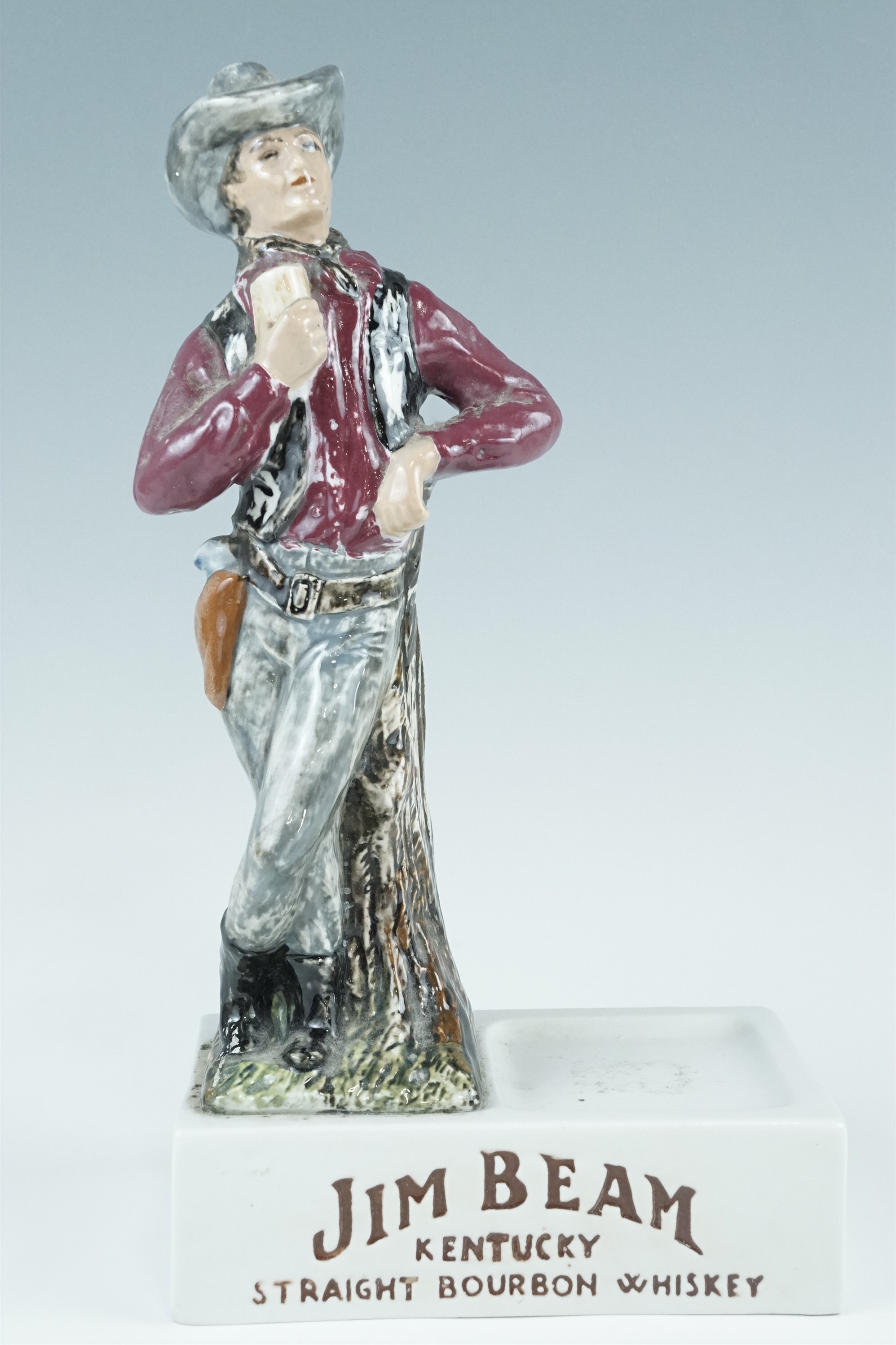 A Jim Beam ceramic counter top figural display stand, modelled as a ...