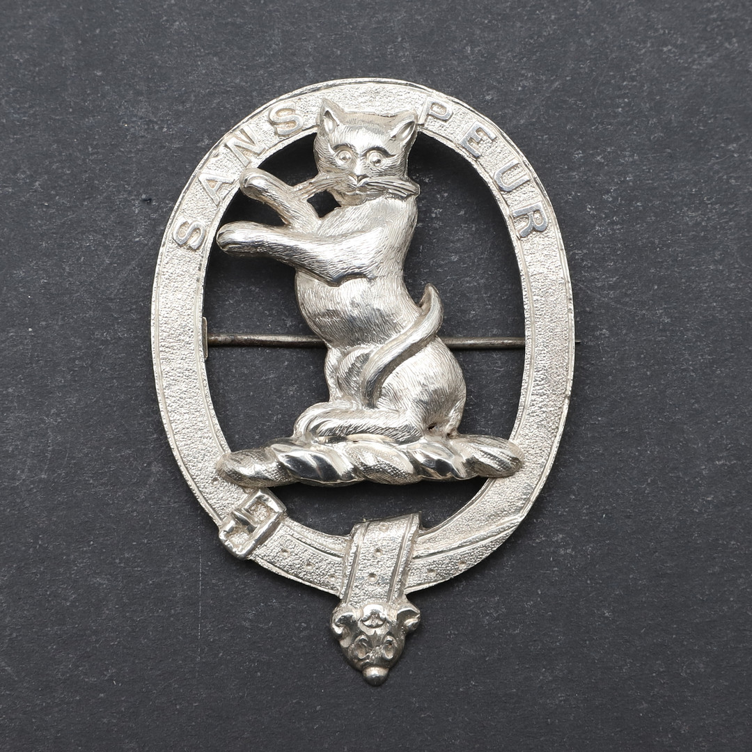 A silver coloured metal Clan Sutherland badge with a wild cat to the ...