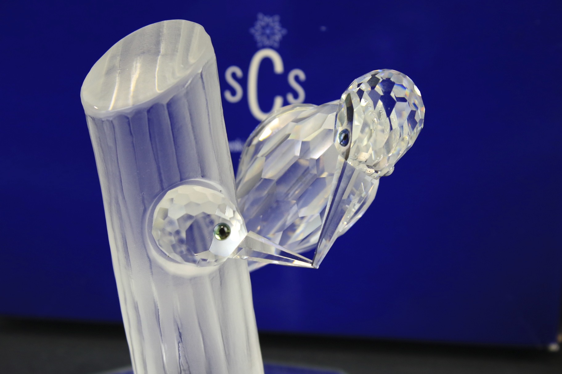Two boxed Swarovski crystal figures of a woodpecker with chick and a ...