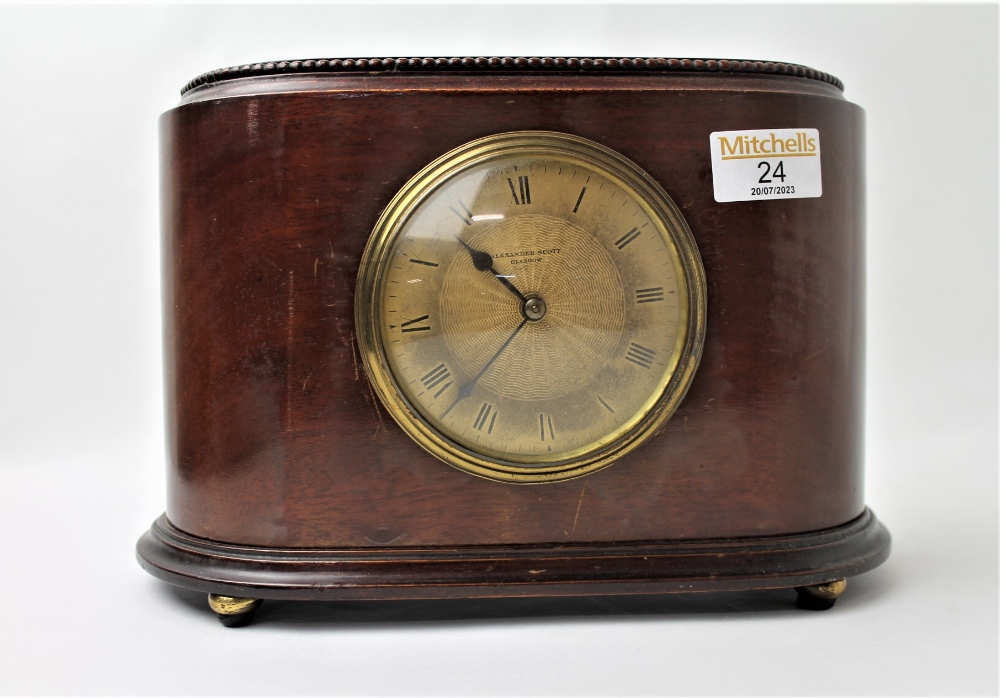 Curved wooden mantle clock by Alexander Scott of Glasgow