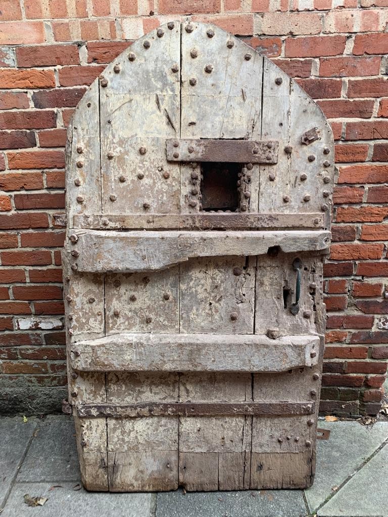 An extremely heavy Medieval Oak lancet-shape castle door, of plank and ...