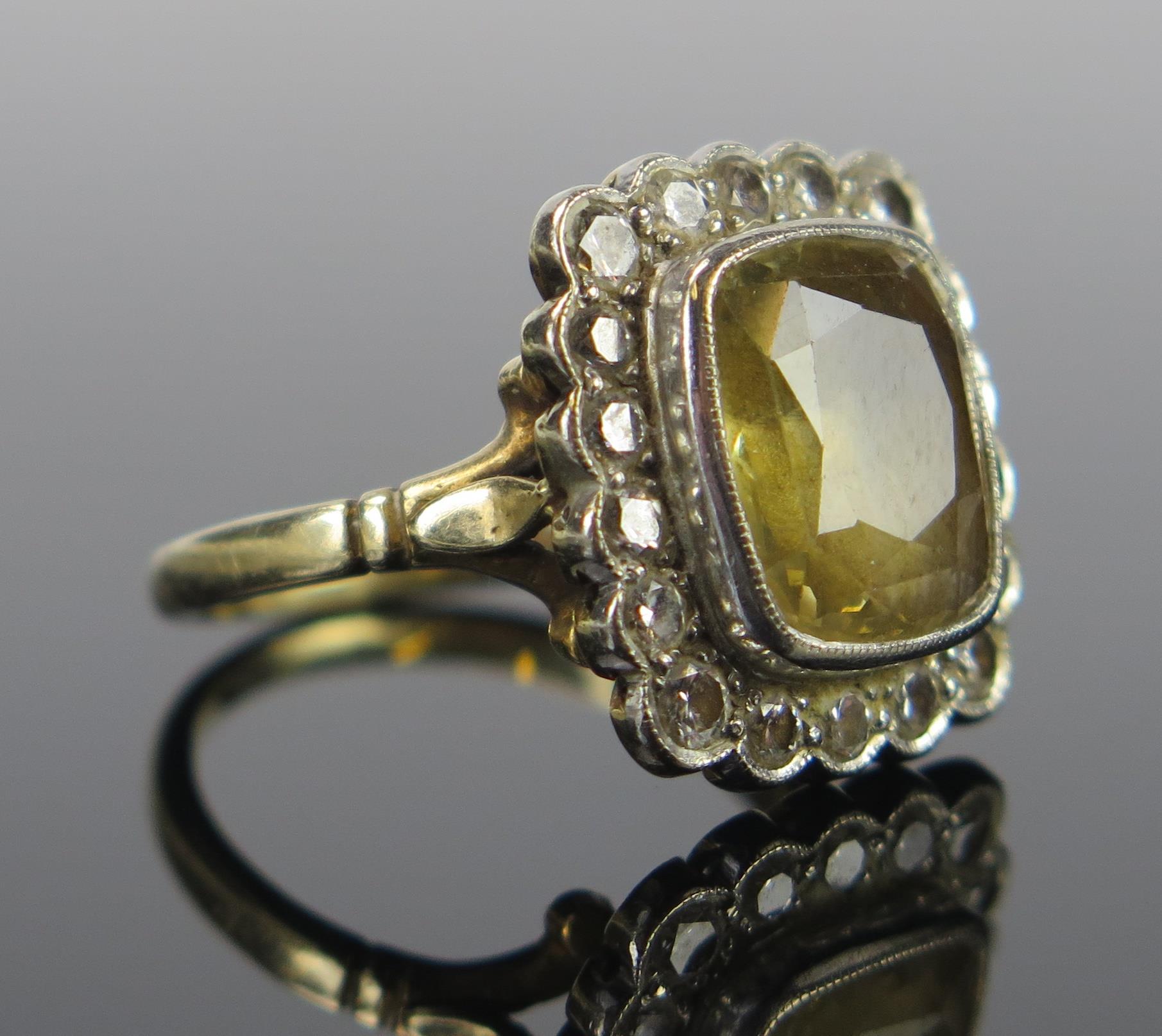 An 18ct Gold, Yellow and Diamond Cluster Ring, the c. 12x11mm stone in ...