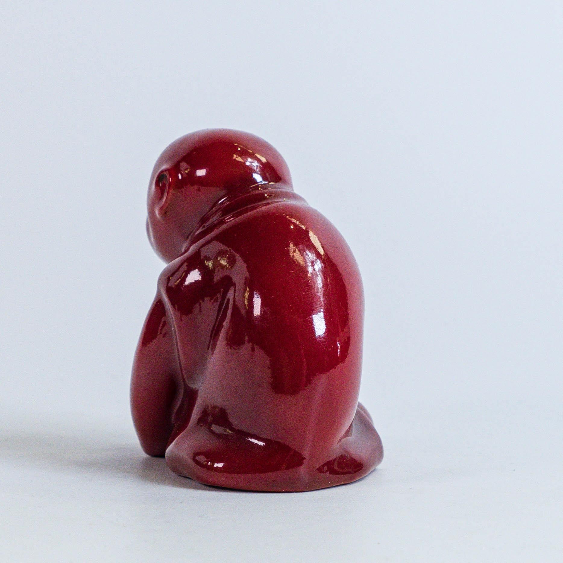 Bernard Moore seated monkey in a red Flambe glaze, height 8cm