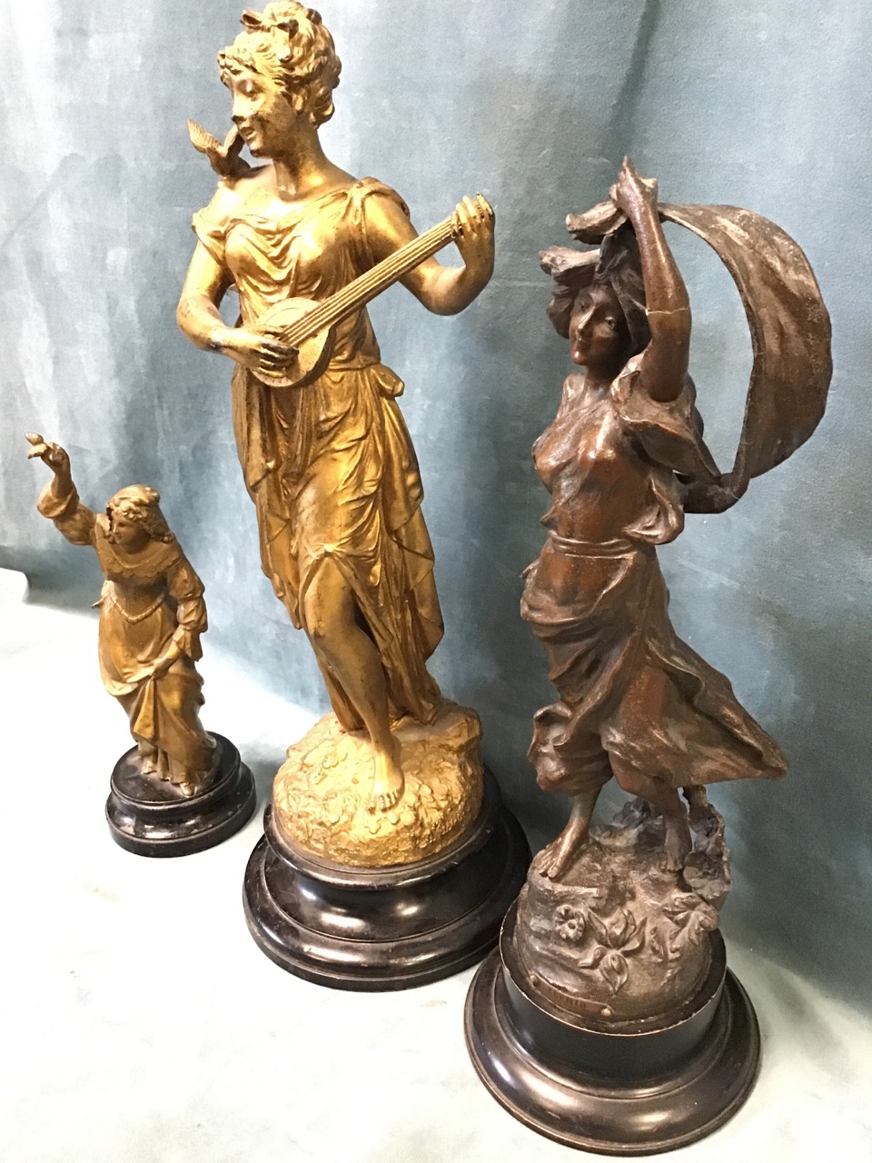 Three late nineteenth century spelter figurines, the bronzed ladies on ...