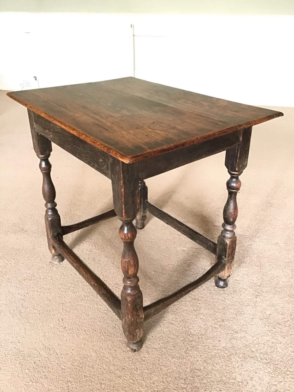 An eighteenth century oak peg-jointed side table with rectangular top ...