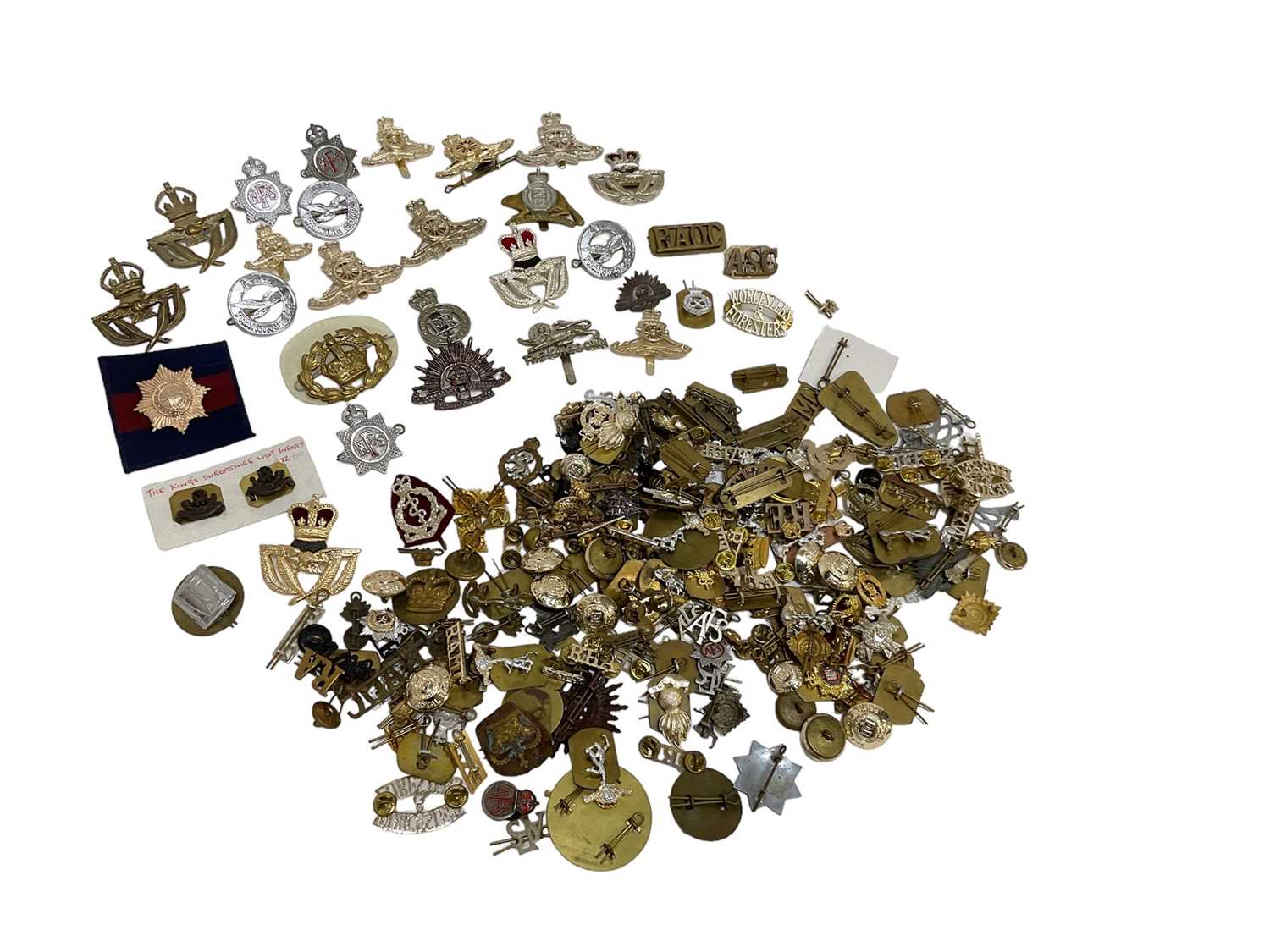 Collection of various British military cap badges, shoulder titles and ...