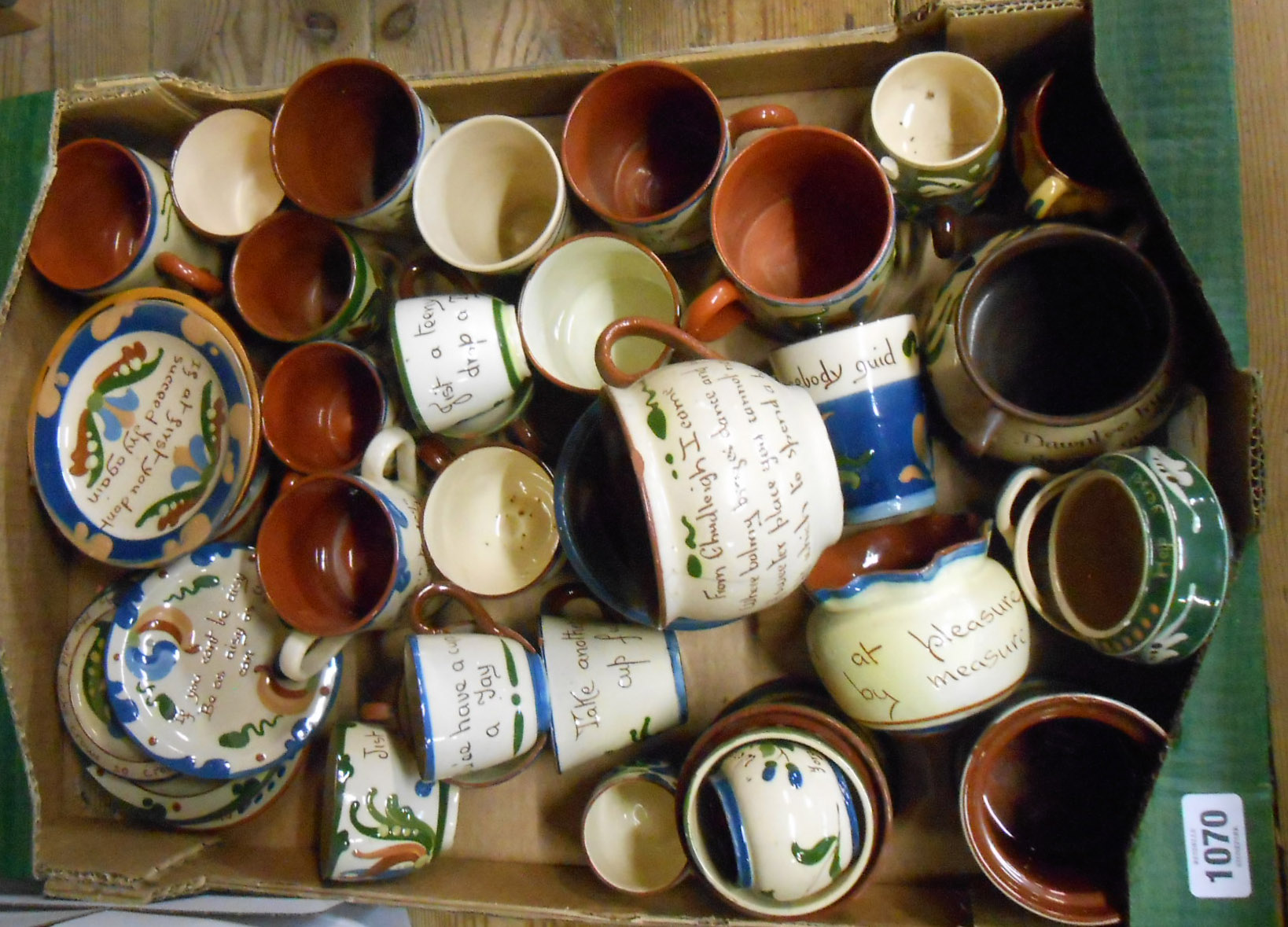 A box containing a quantity of Torquay pottery including mugs, cups and ...