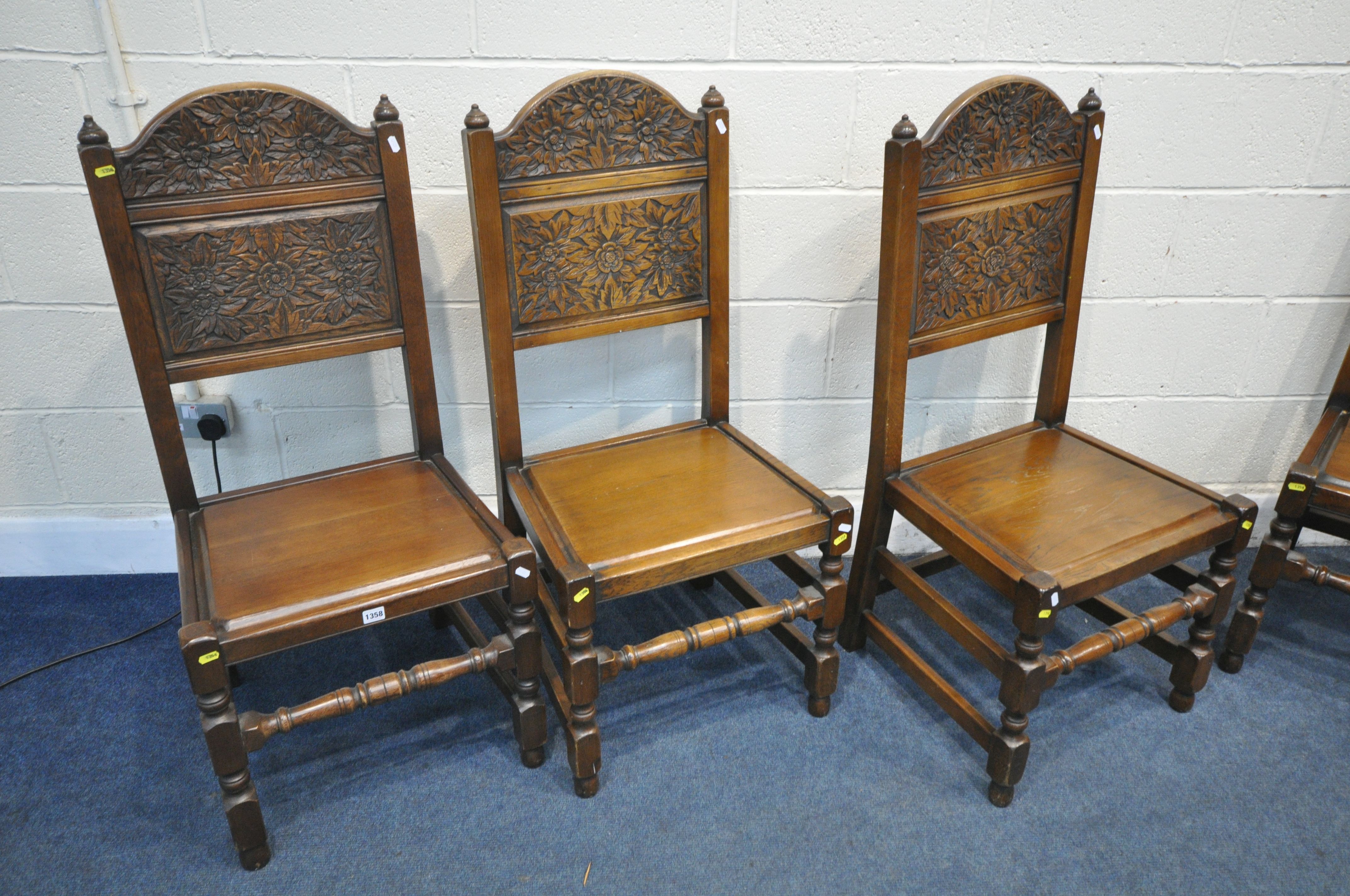 A SET OF SIX REPRODUCTION OAK DINING CHAIRS, with carved back of flower ...