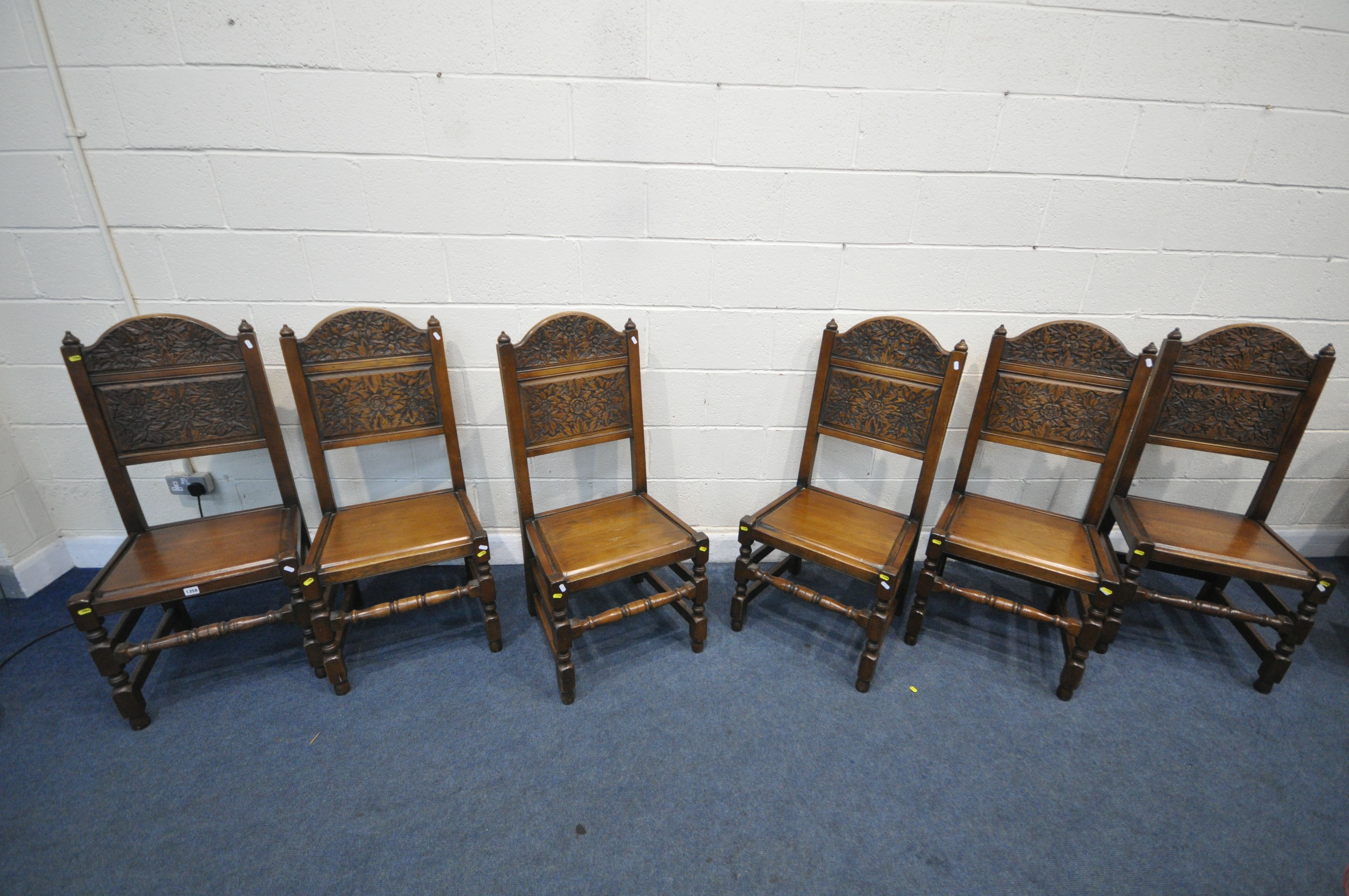 A SET OF SIX REPRODUCTION OAK DINING CHAIRS, with carved back of flower ...