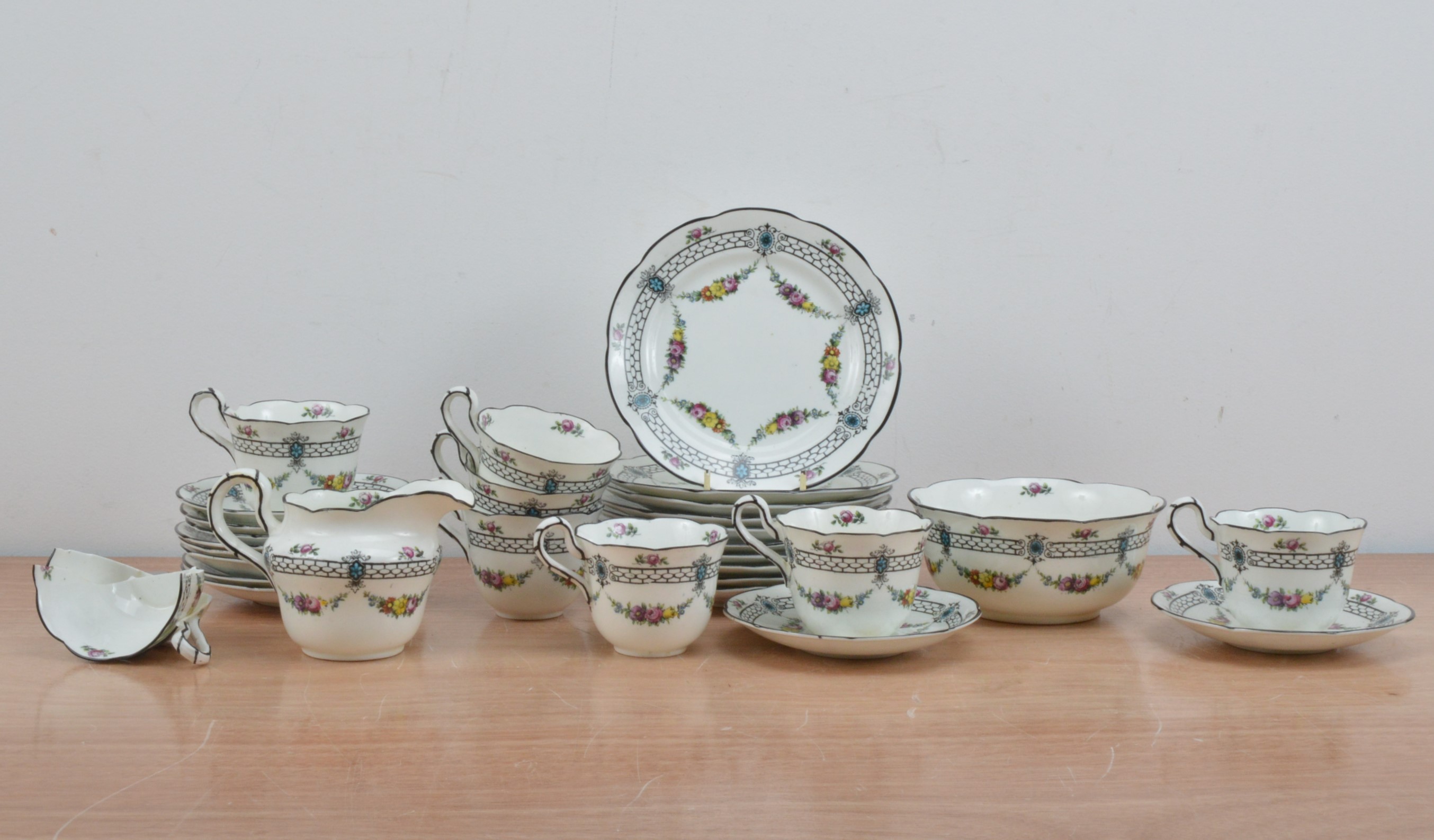 A Collingwood porcelain part tea service, white ground with black and ...
