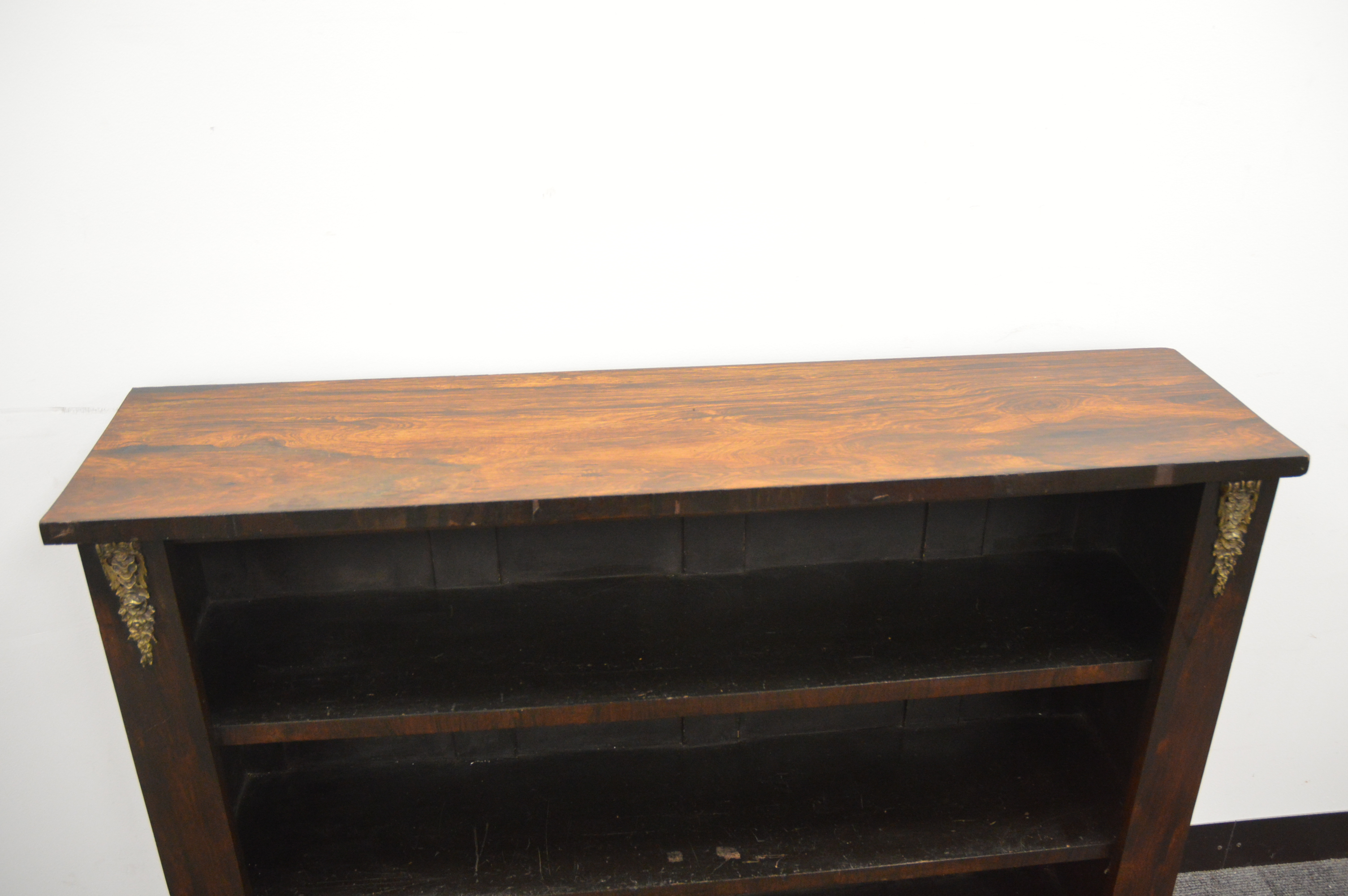 A late 19th century rosewood veneered bookcase, the top slightly warped ...