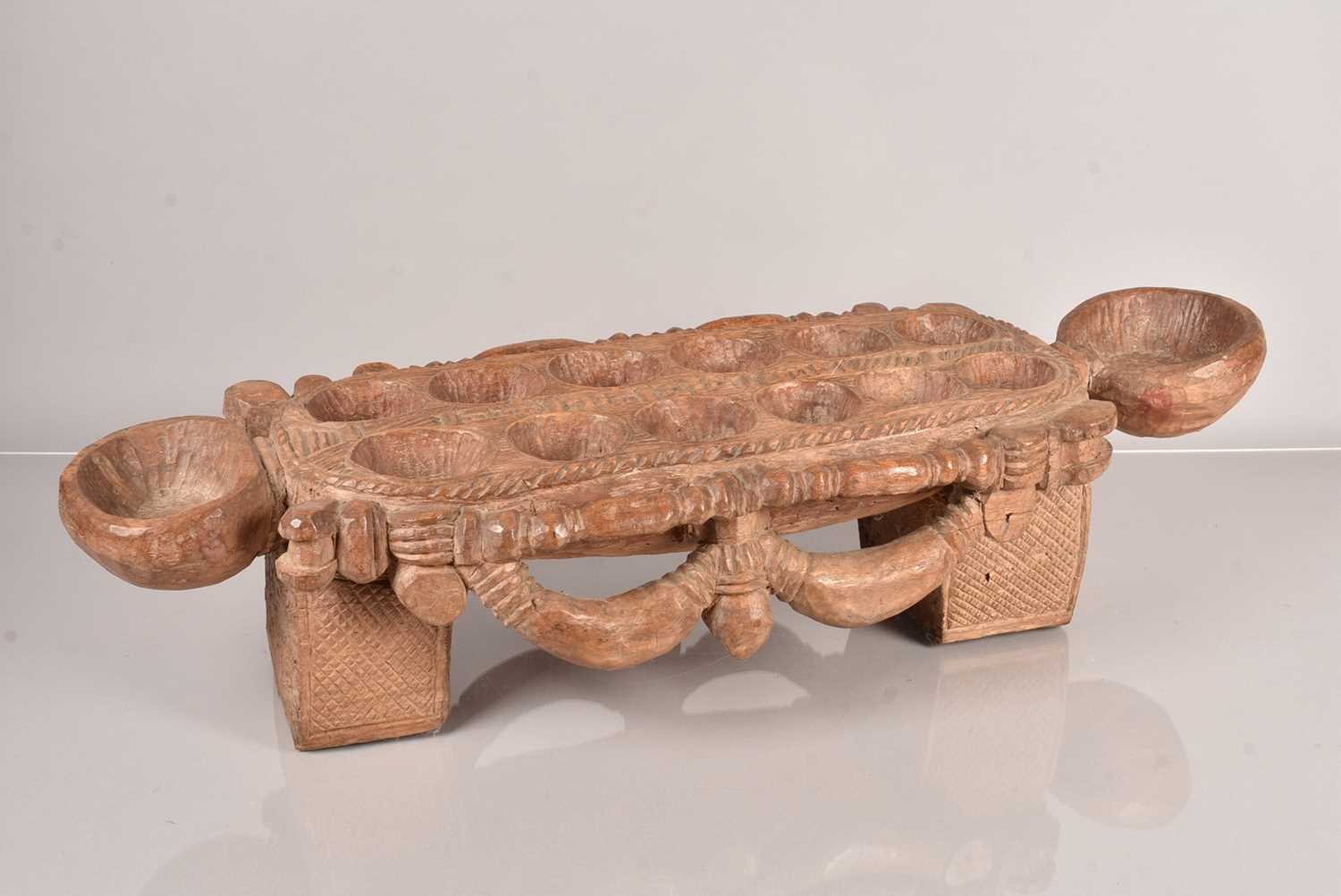 An African Mancala Board, the hand carved wooden game board on broad ...