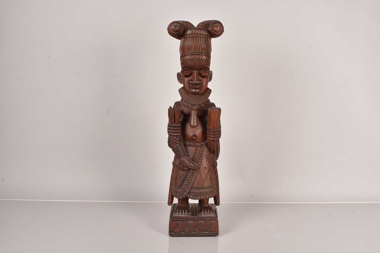 Joseph Adeyemi Fakeye, B.1931, a large carved figure of a male holding ...