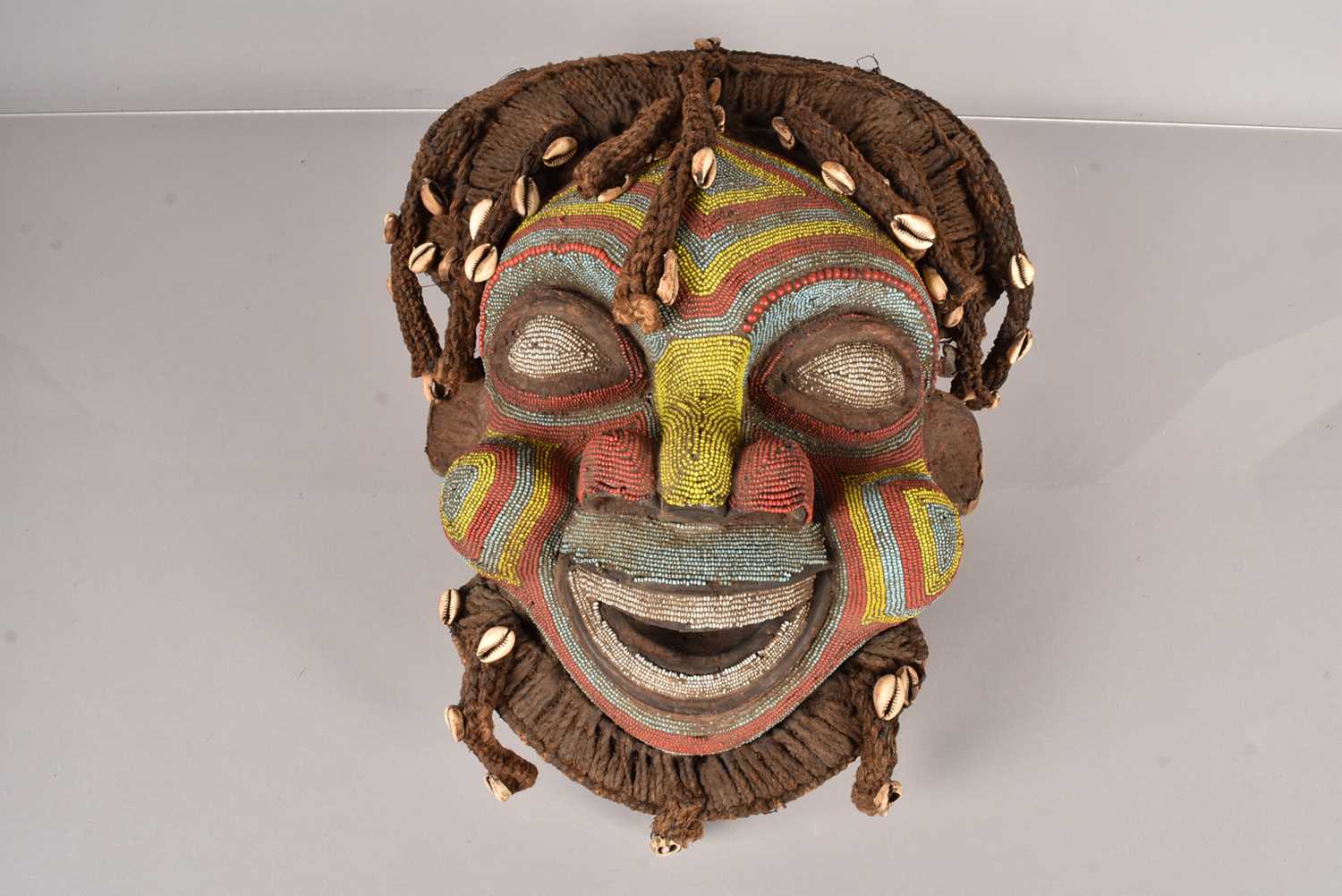 A carved and beaded African Bamileke Mask, (Cameroon)the coloured beads ...