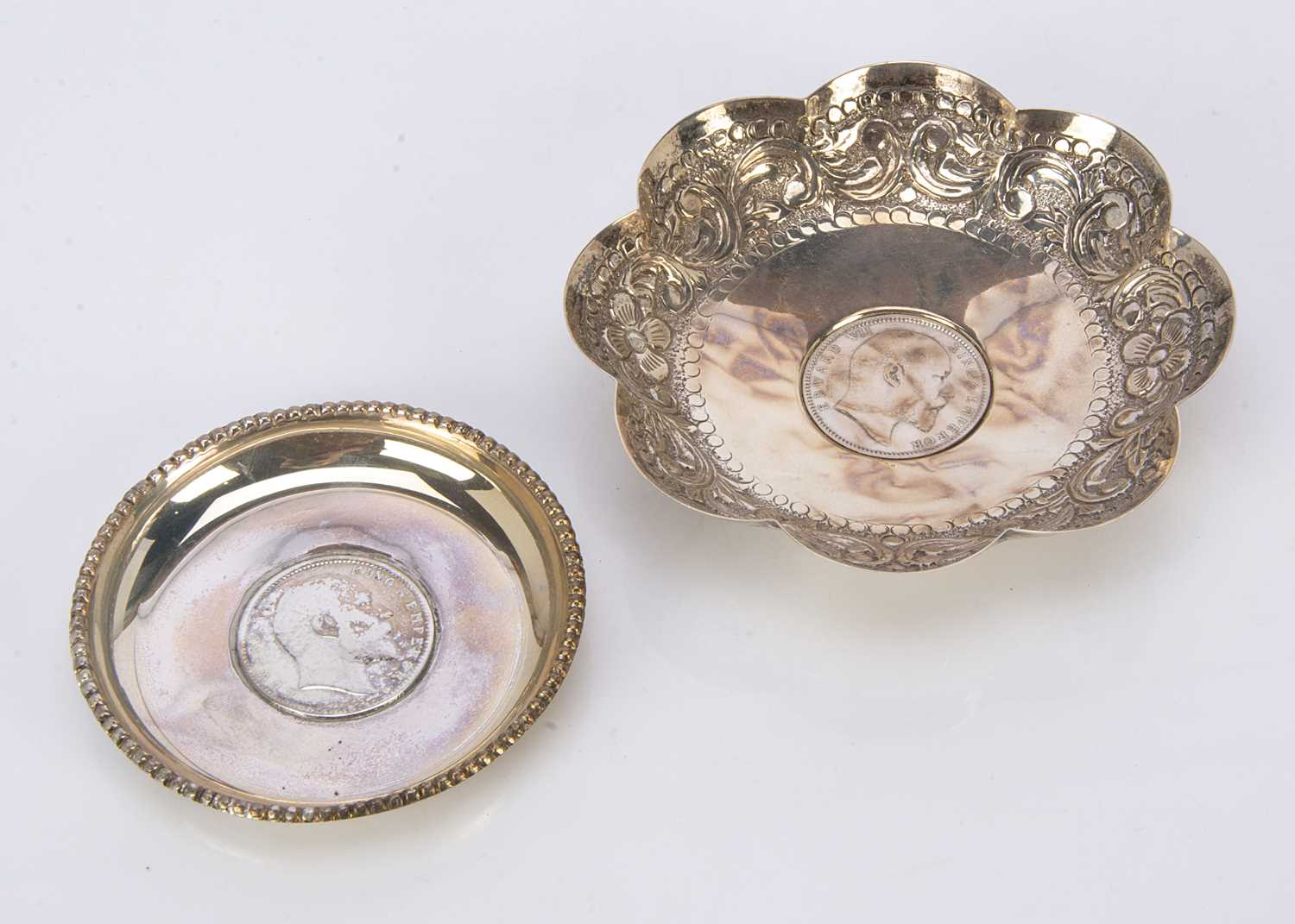 Two Indian dishes with inset Edward VII one rupee coins, the larger 10 ...