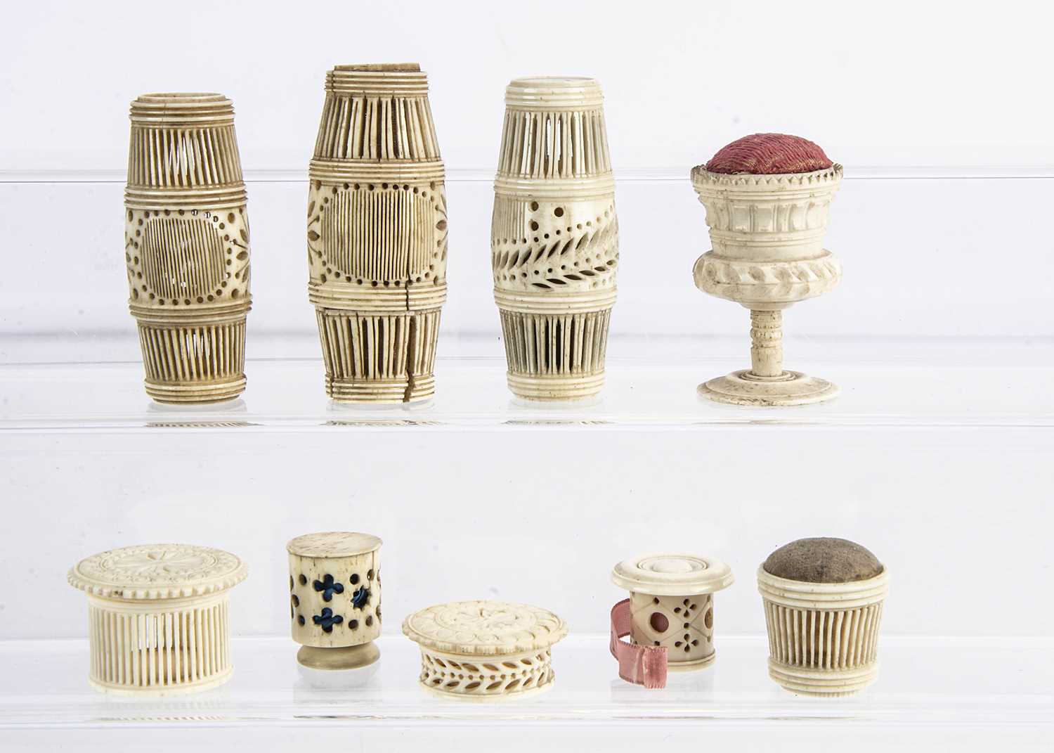 19th century bone sewing accessories, a carved bone pincushion on stand ...