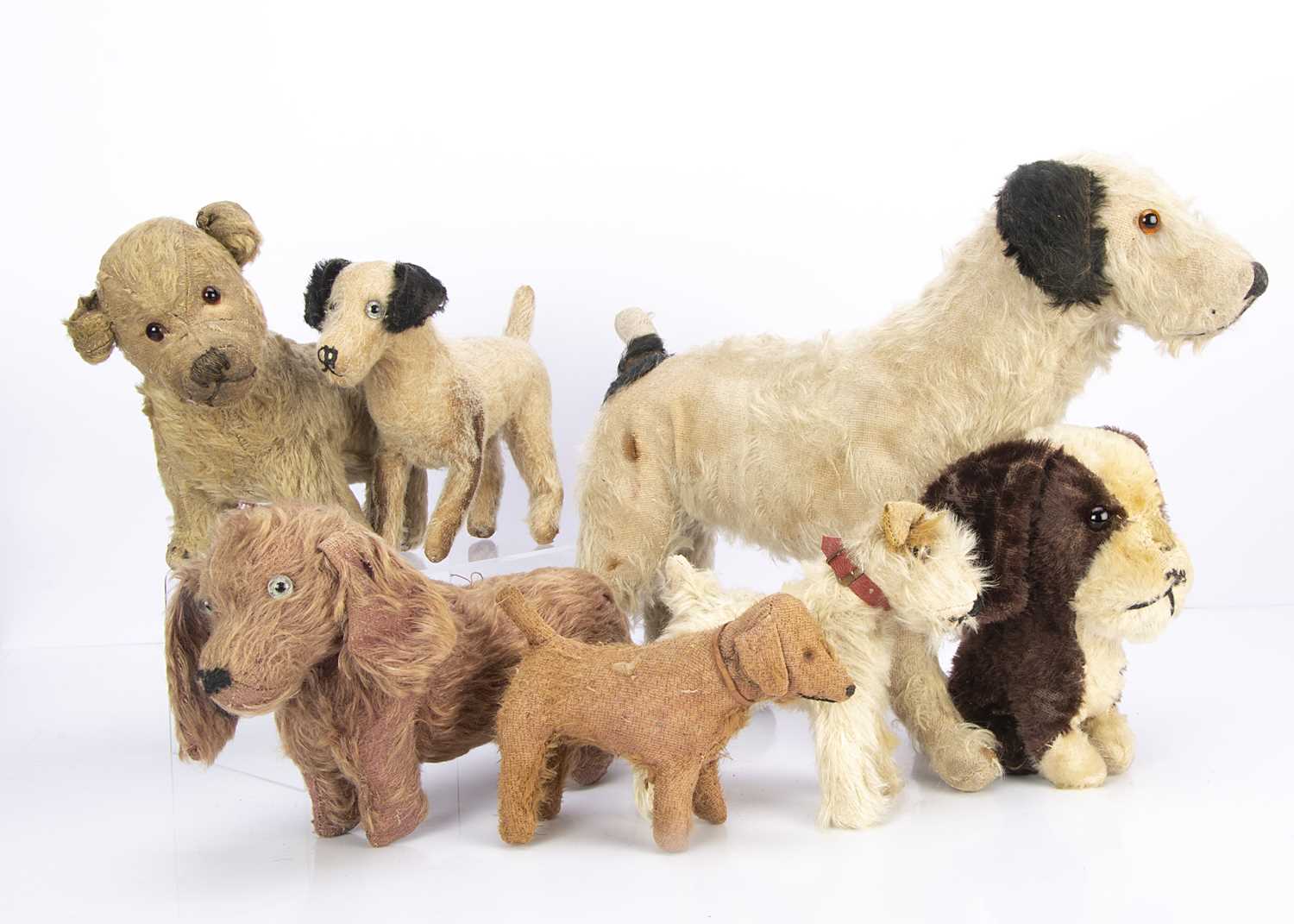 Seven soft toy dogs 1920-30s, a white mohair British standing dog with ...