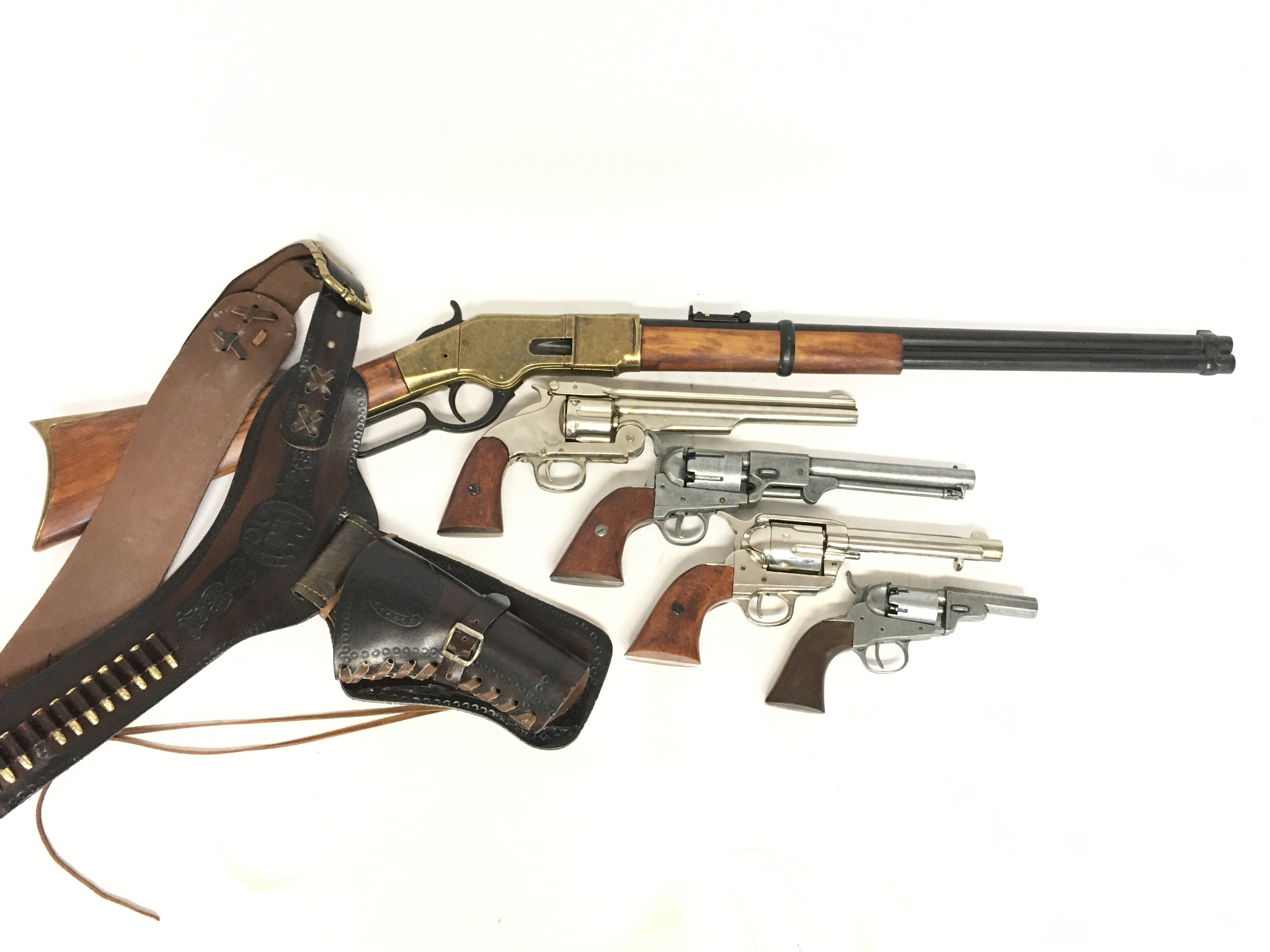 Replica guns including a collection of revolvers and a Winchester rifle ...