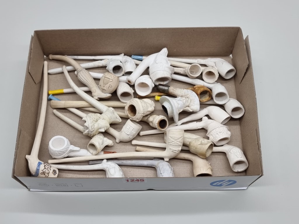A collection of clay pipes, to include: a football example; 'The Blues ...