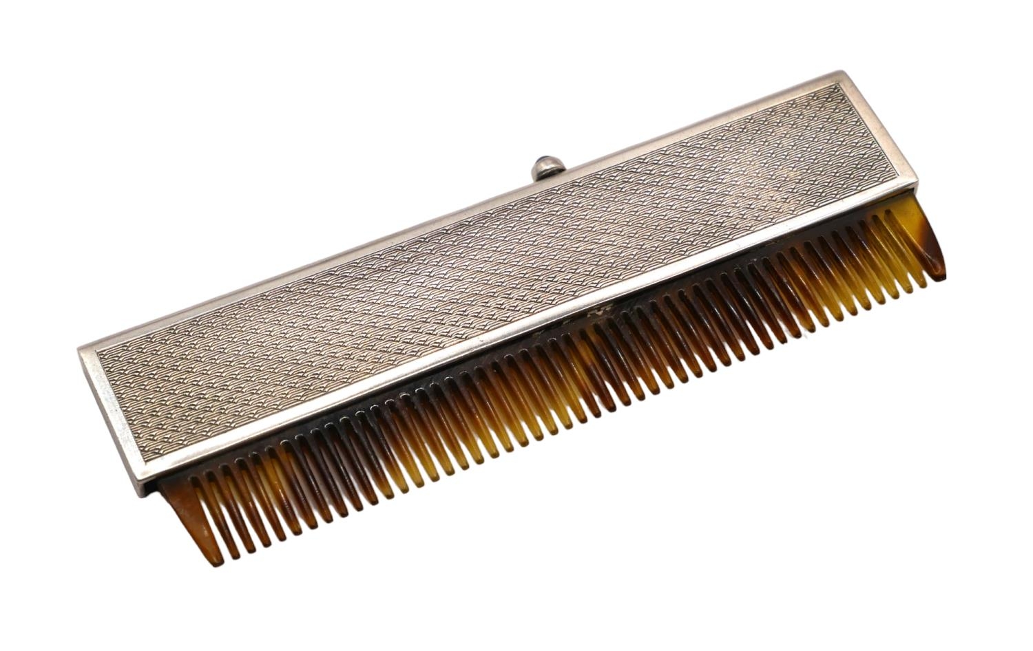 ISRAEL SEGALOV, AN ART DECO SILVER & SAPPHIRE CABOCHON MECHANICAL COMB ...