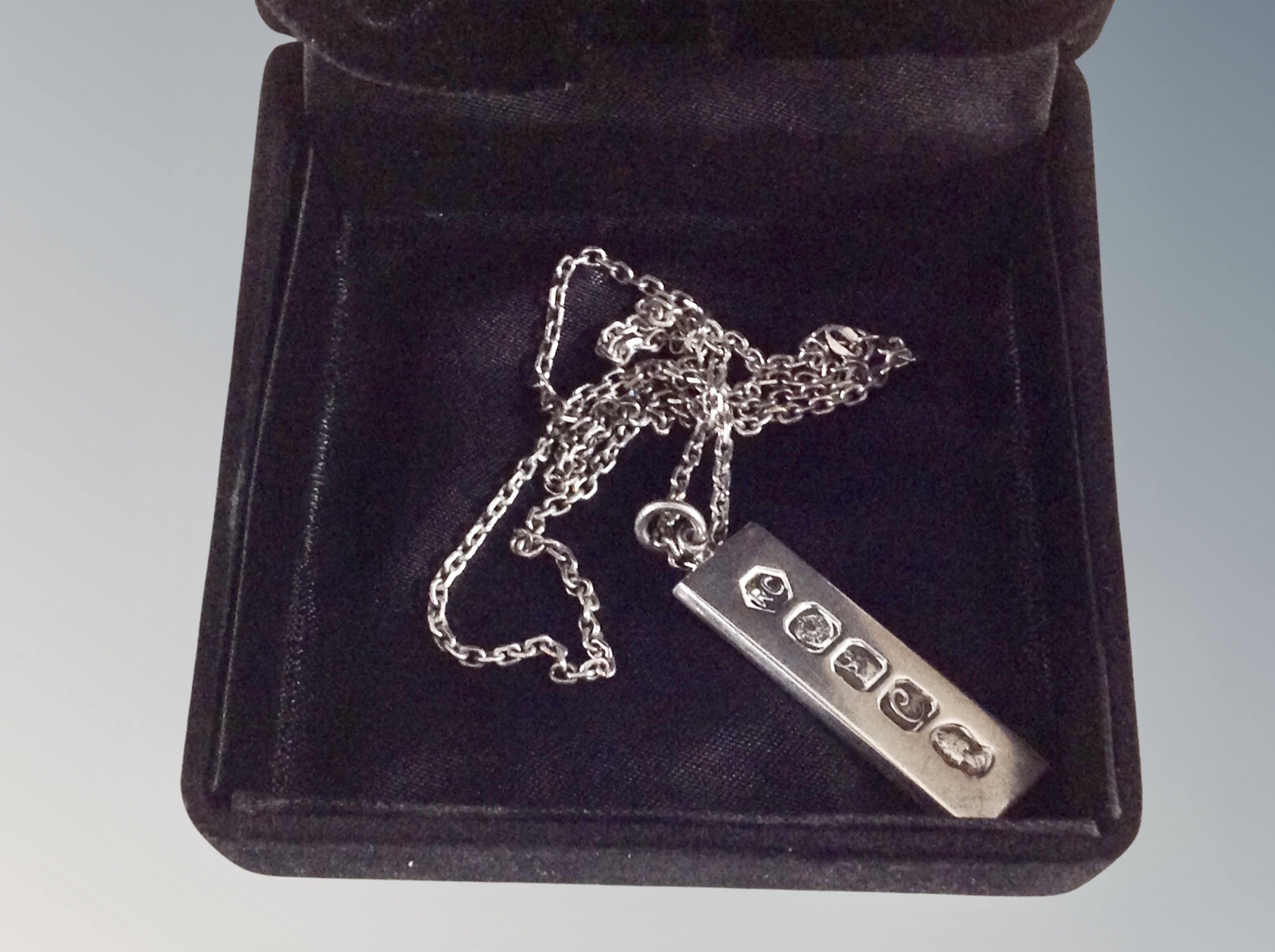 A silver chain and ingot pendant, Sheffield 1977