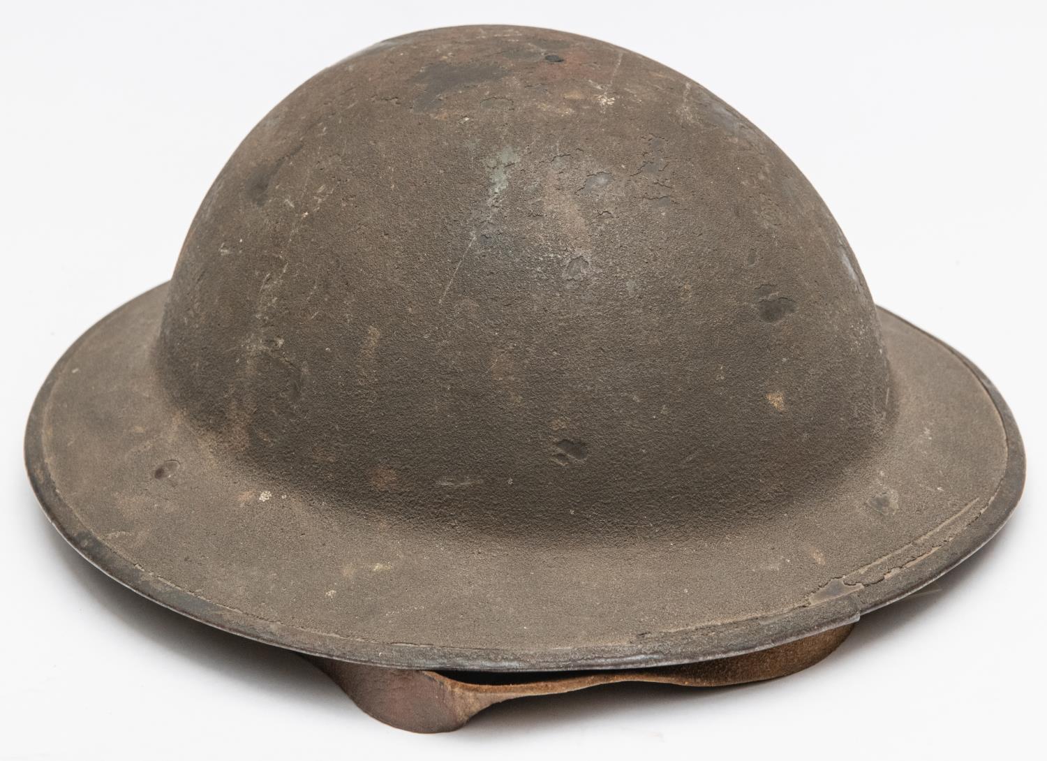 A WWI 2nd type steel "Brodie" helmet, with bound edge, complete oilskin ...