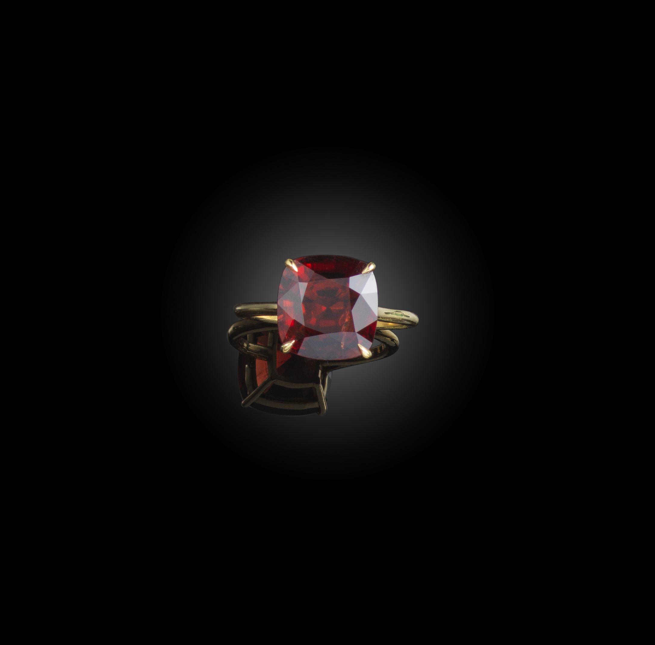 A spinel solitaire ring, the cushion-shaped spinel weighing 6.25cts ...