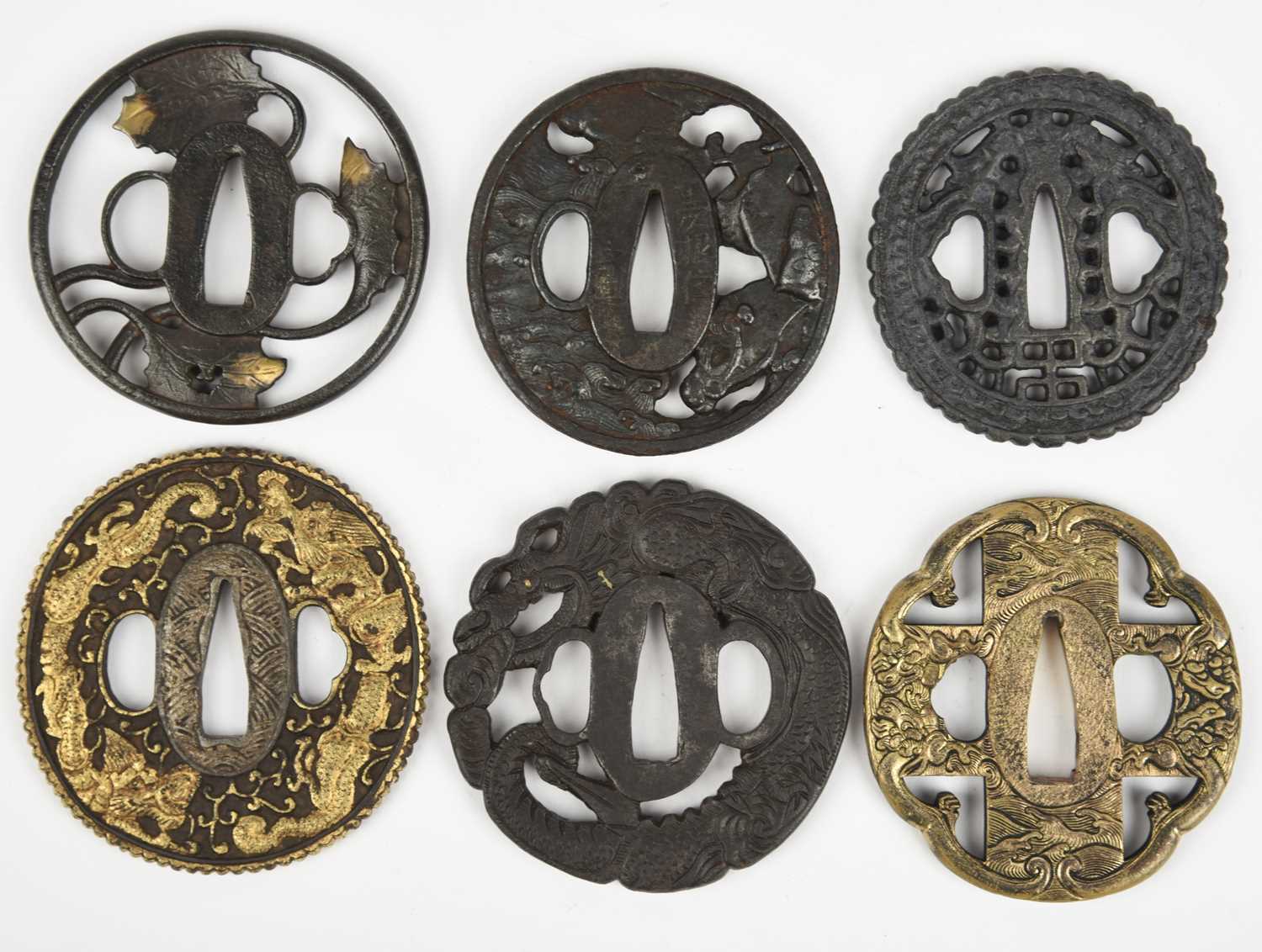 Six Japanese sword guards (tsuba), the first maru-gata, with an ...