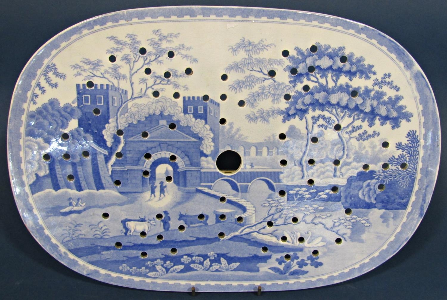 A 19th century Spode gravy drainer with printed detail showing the ...