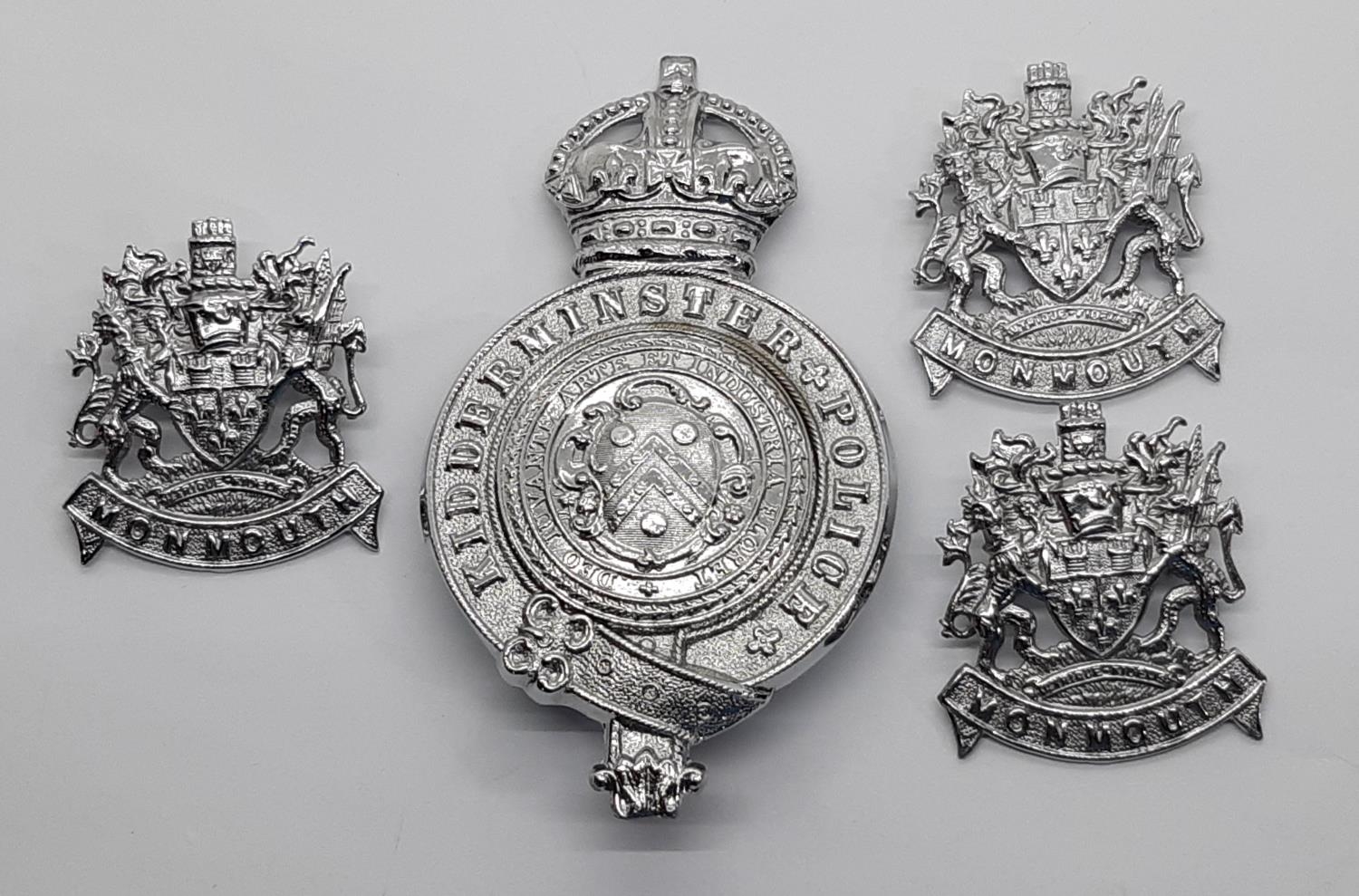 A Kidderminster Police Constabulary helmet badge together with three ...
